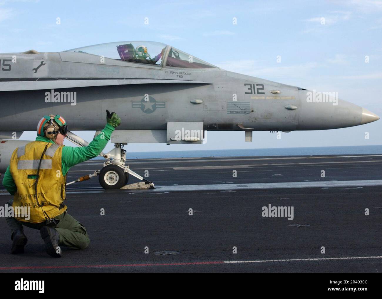US Navy A flight deck safety observer gives the thumbs up to launch ...