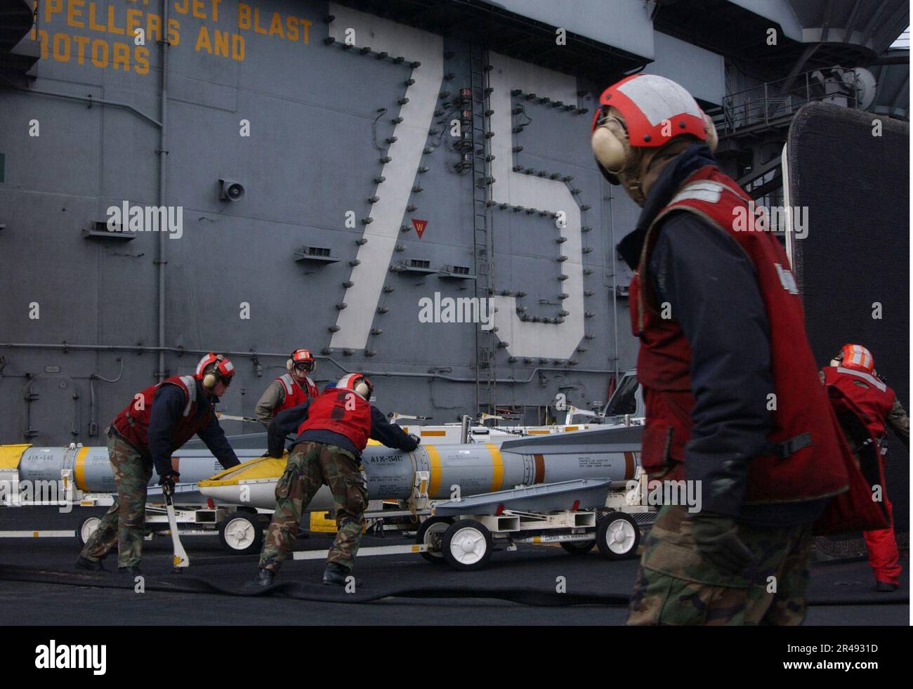 US Navy Aviation Ordnanceman aboard the aircraft carrier USS Harry S ...