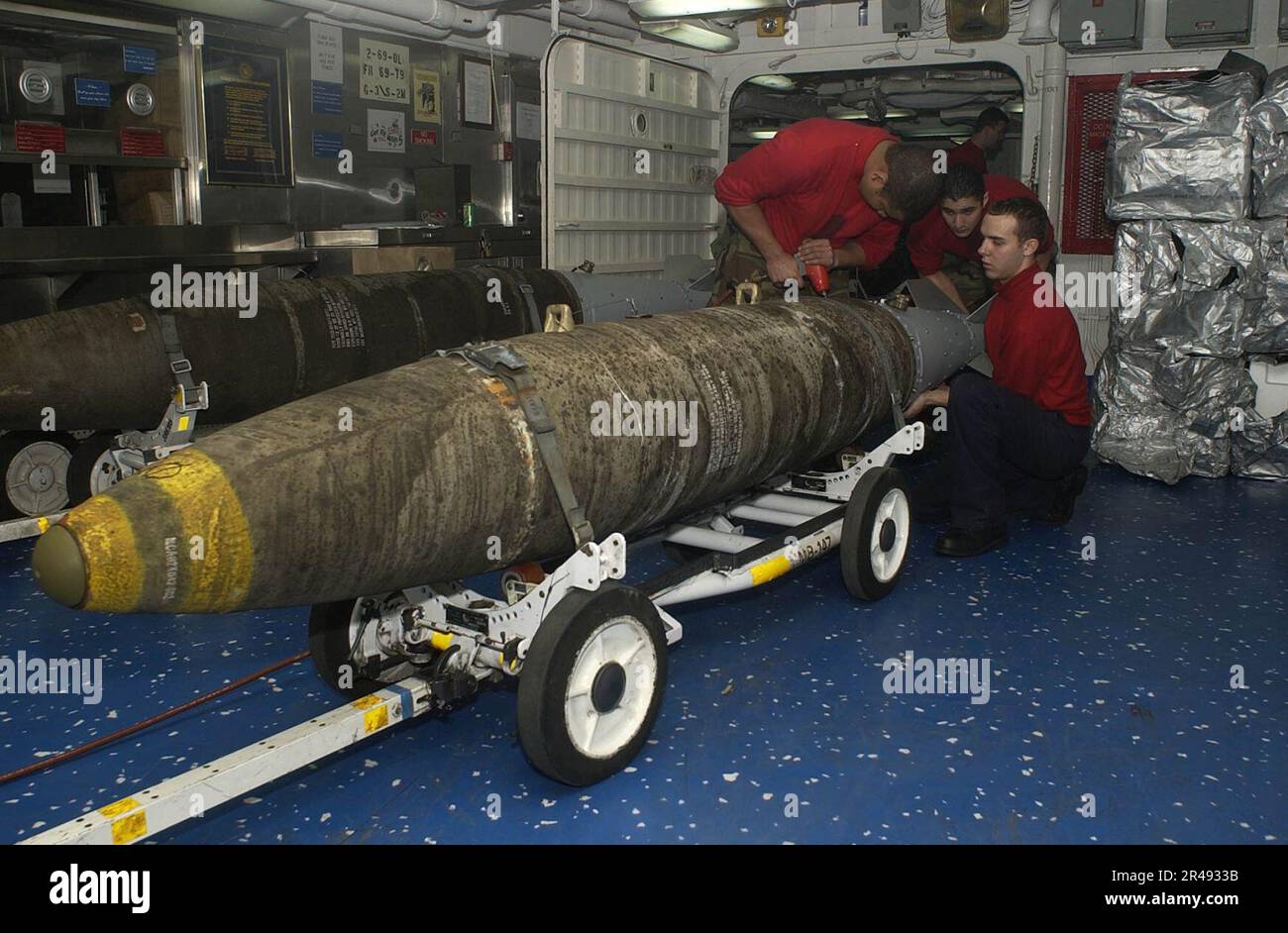 US Navy Aviation Ordnanceman Airmen Josh Dowdy, Rogelio Rosales, and ...