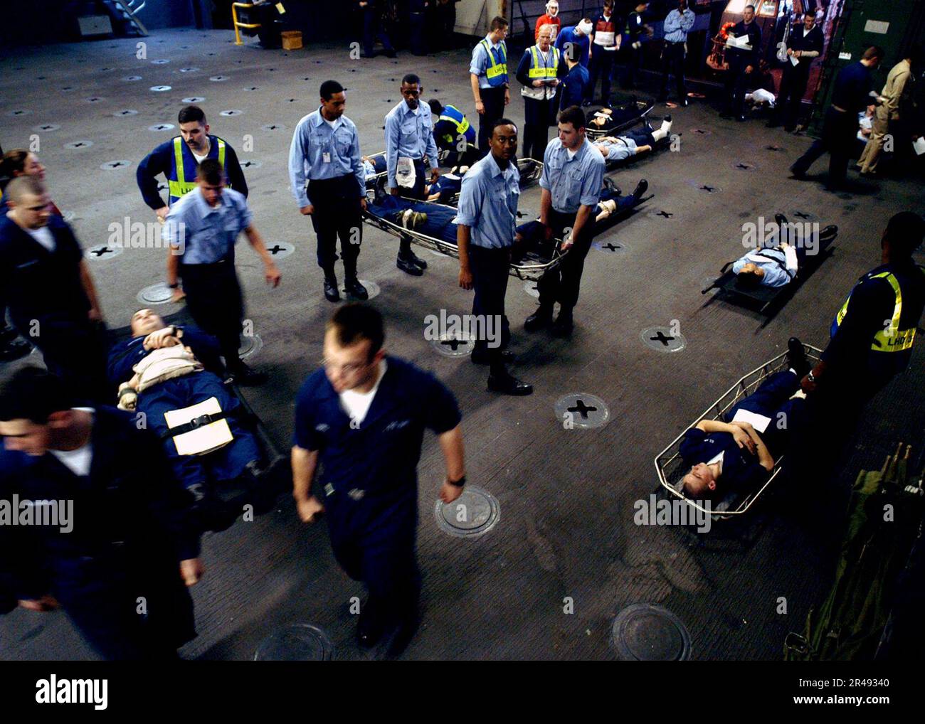 US Navy Medical personnel aboard and stretcher-bearers attend to simulated casualties during a ...
