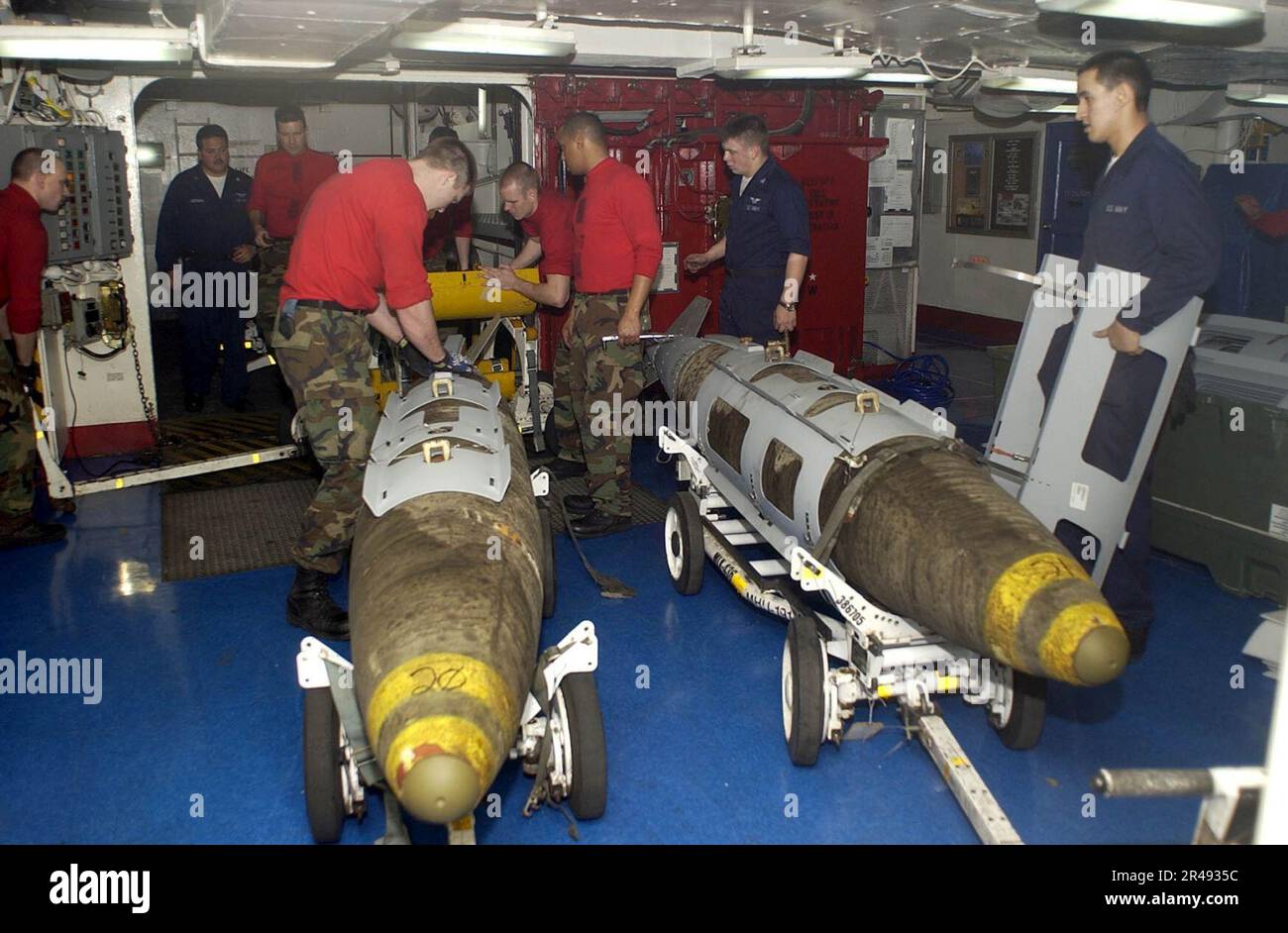 US Navy Ordnance handlers assemble Joint Direct Attack Munition (JDAM ...