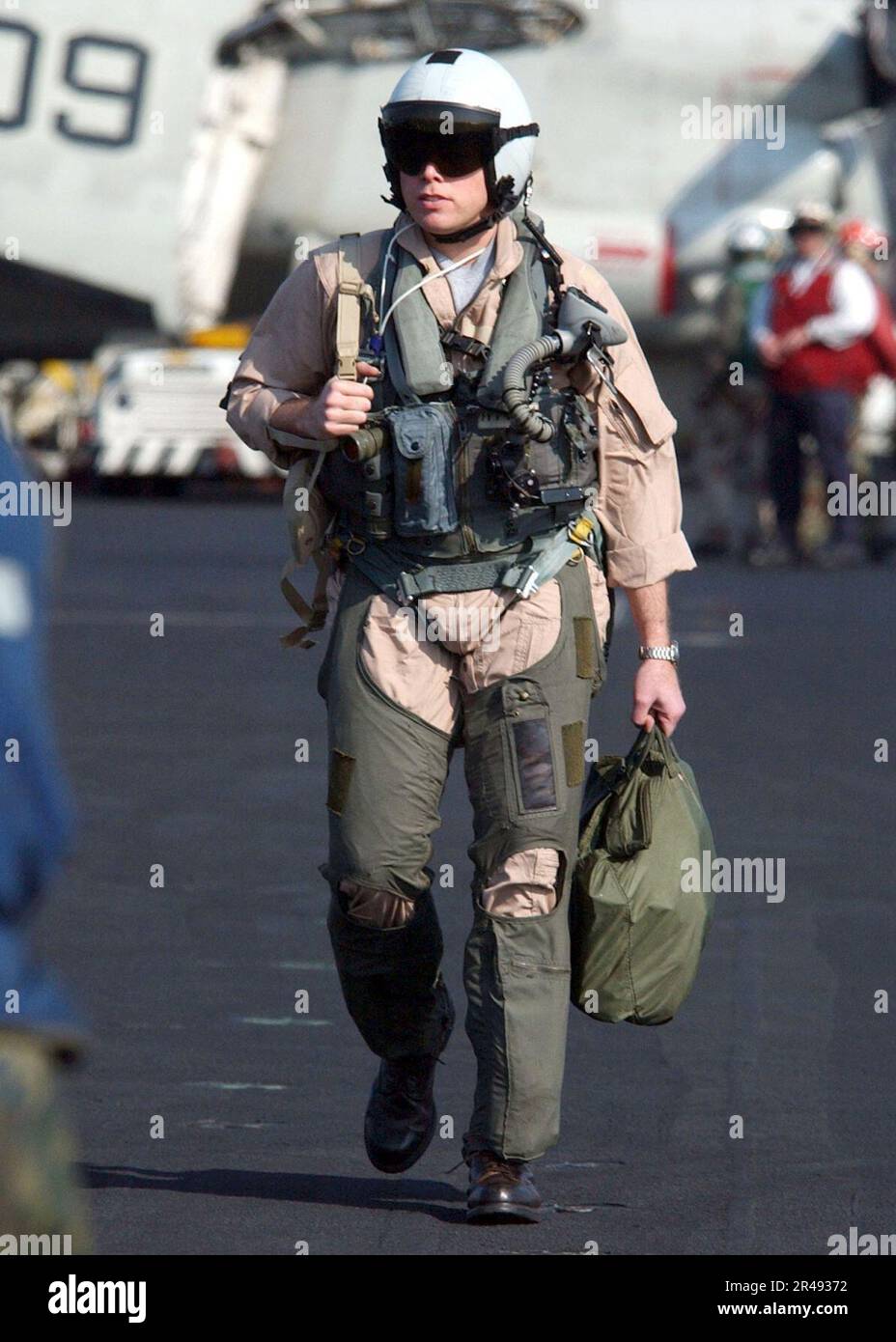 US Navy A pilot makes his way to his aircraft as flight operations ...