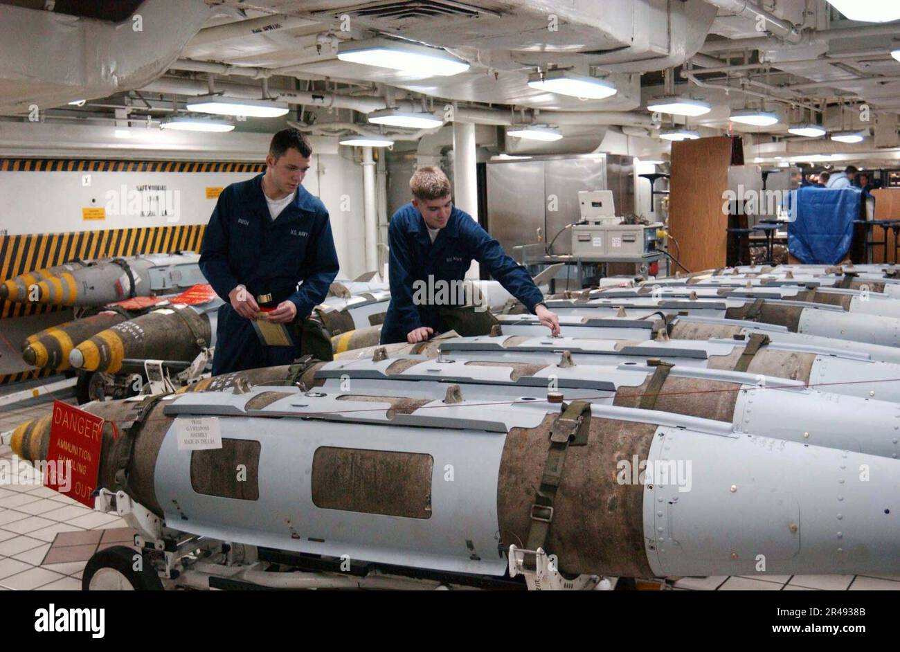 US Navy Aviation Ordnancemen inspect a Joint Direct Attack Munition ...