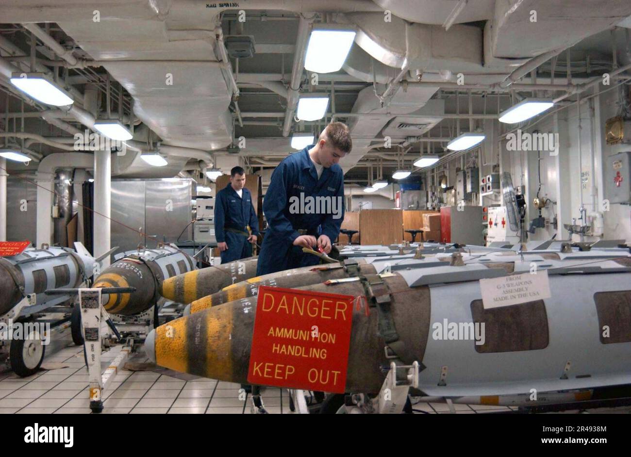 US Navy Aviation Ordnancemen inspect a Joint Direct Attack Munition ...