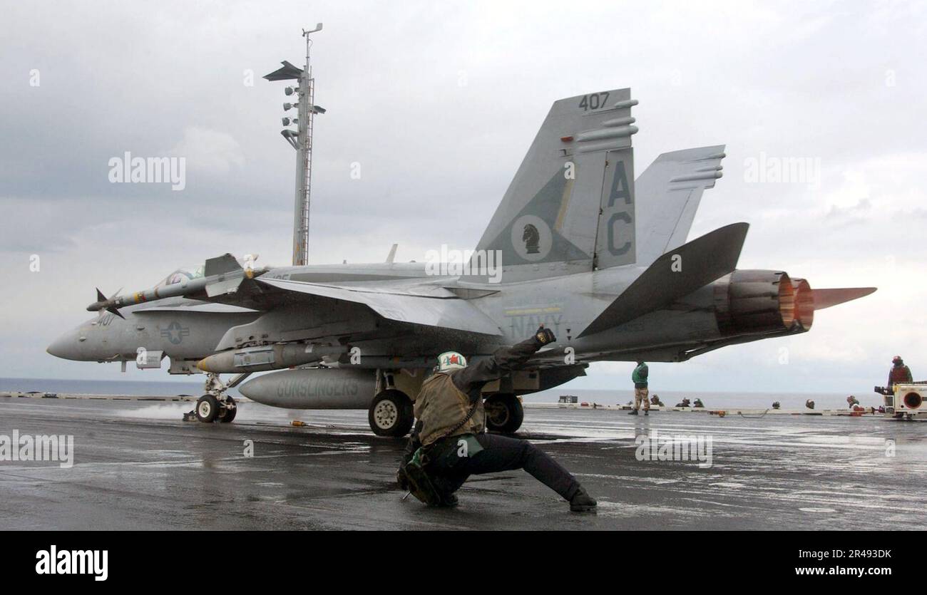 US Navy A Trouble Shooter performs final checks on an F-A 18 Hornet ...