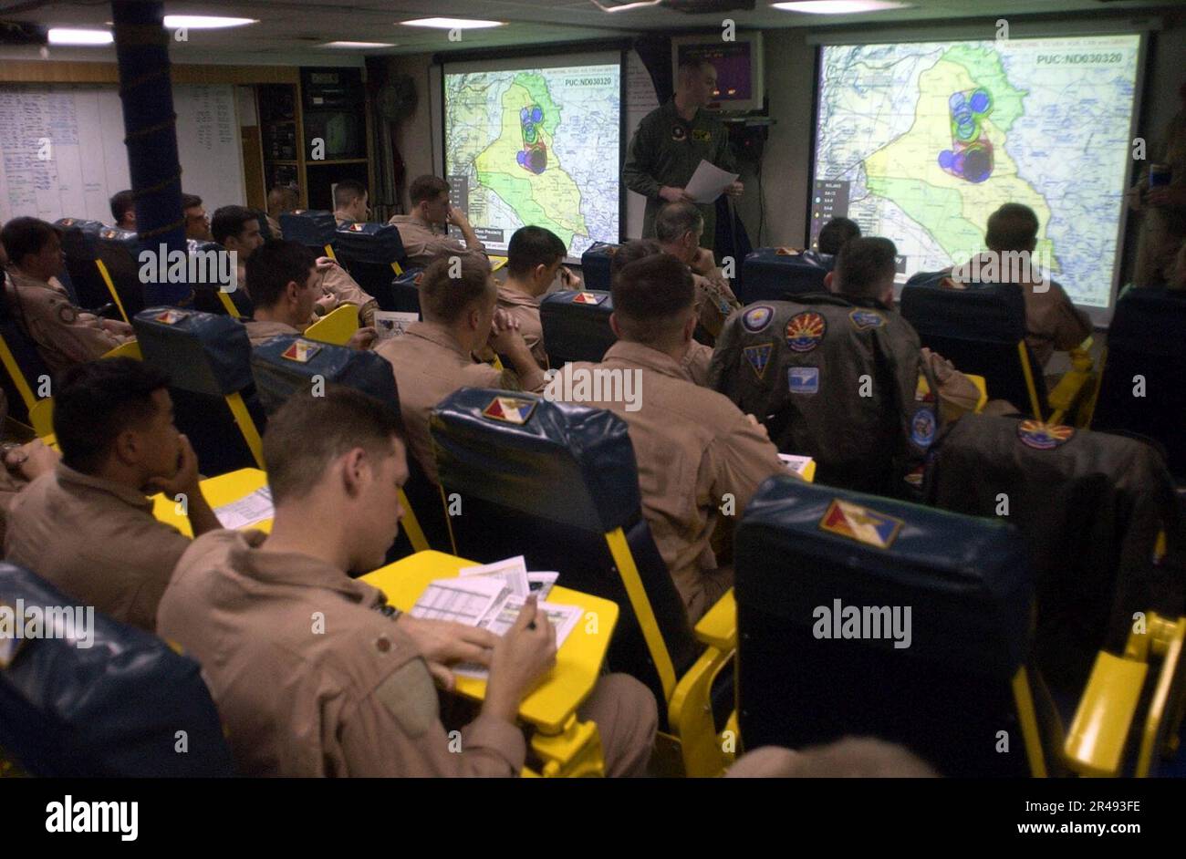 US Navy Pilots assigned to Carrier Air Wing Two (CVW-2) listen to a pre ...