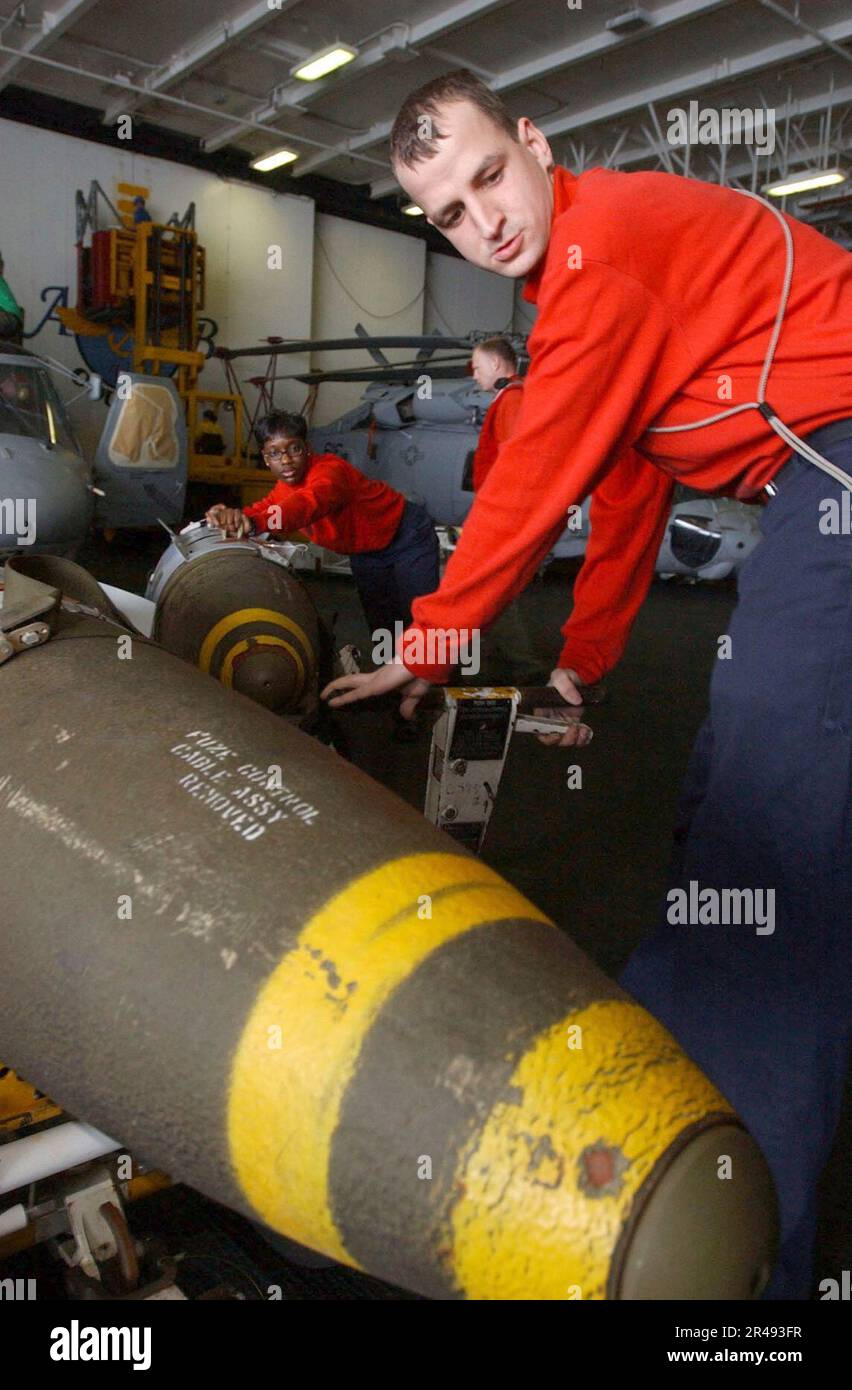 US Navy An Aviation Ordnanceman moves a 2,000 lb. Joint Directional ...
