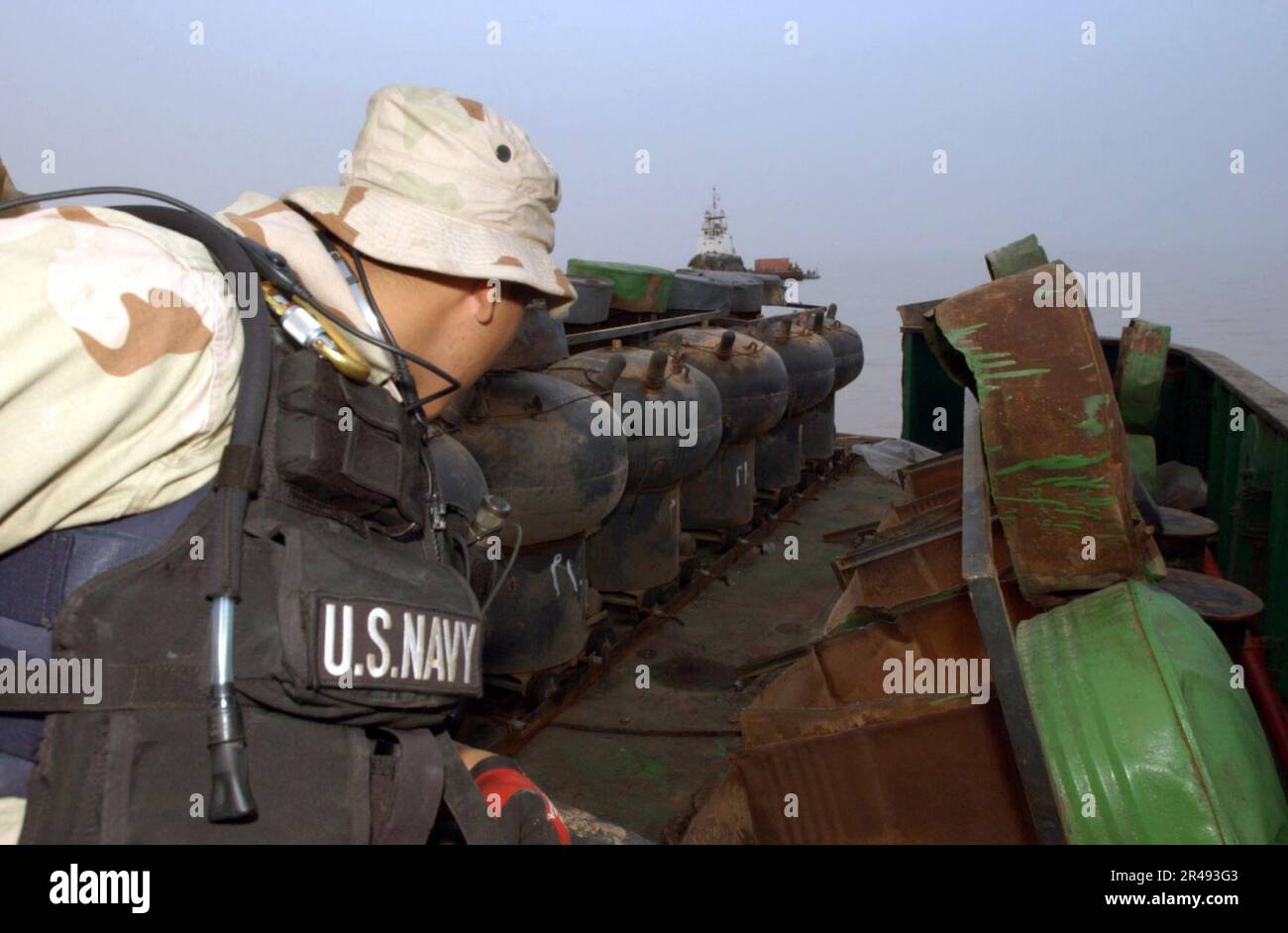 US Navy A Vessel, Board, Search and Seizure (VBSS) team member inspects ...