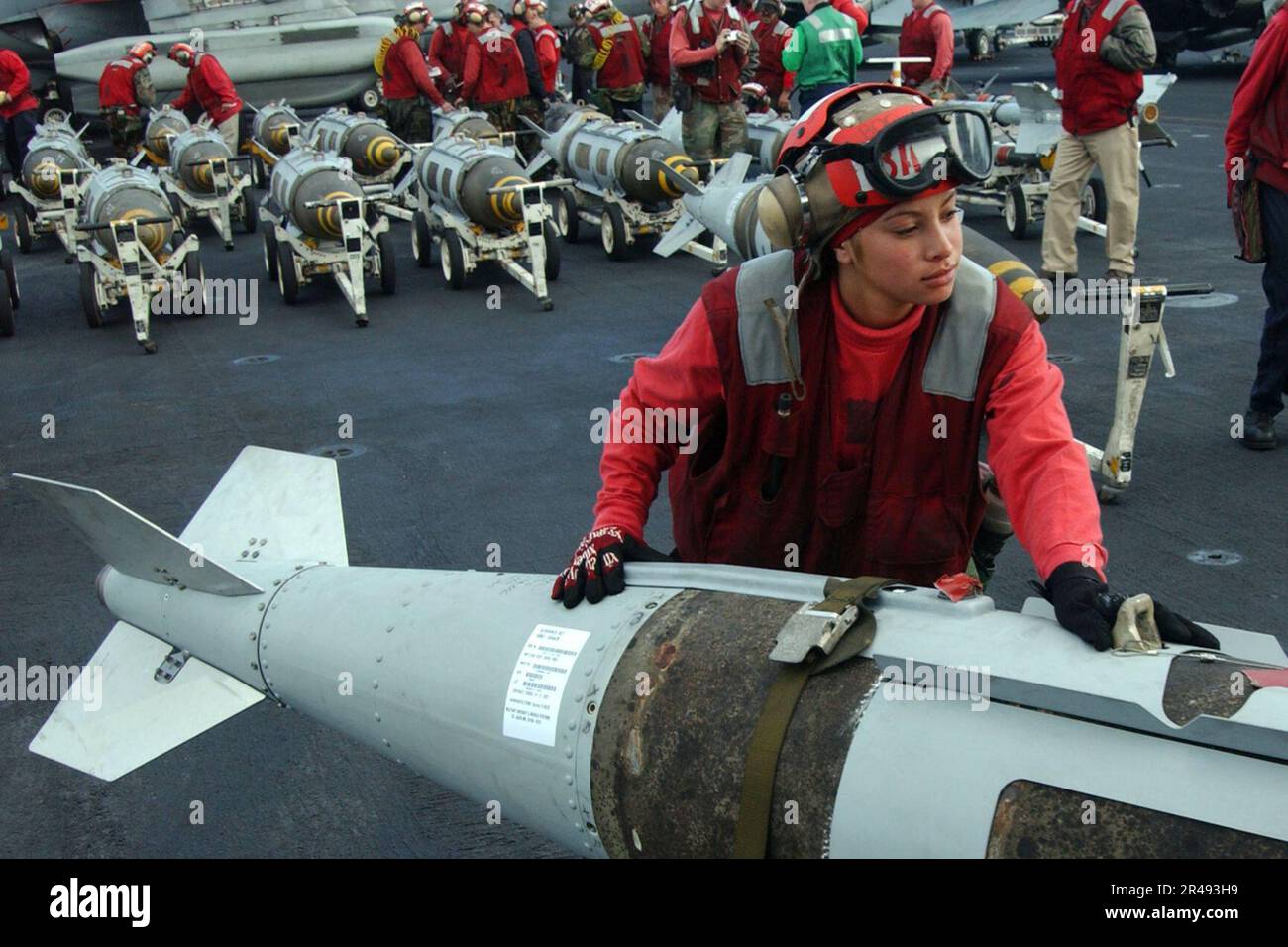 US Navy Aviation Ordnancemen move a 2000 lbs GBU-31 Joint Direct Attack ...