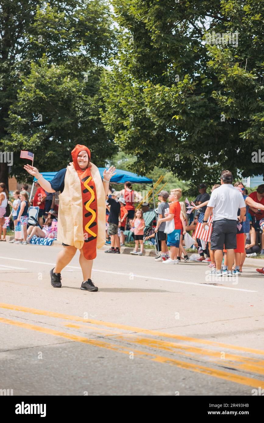A crowd of people in bright and colourful costumes marching in a ...