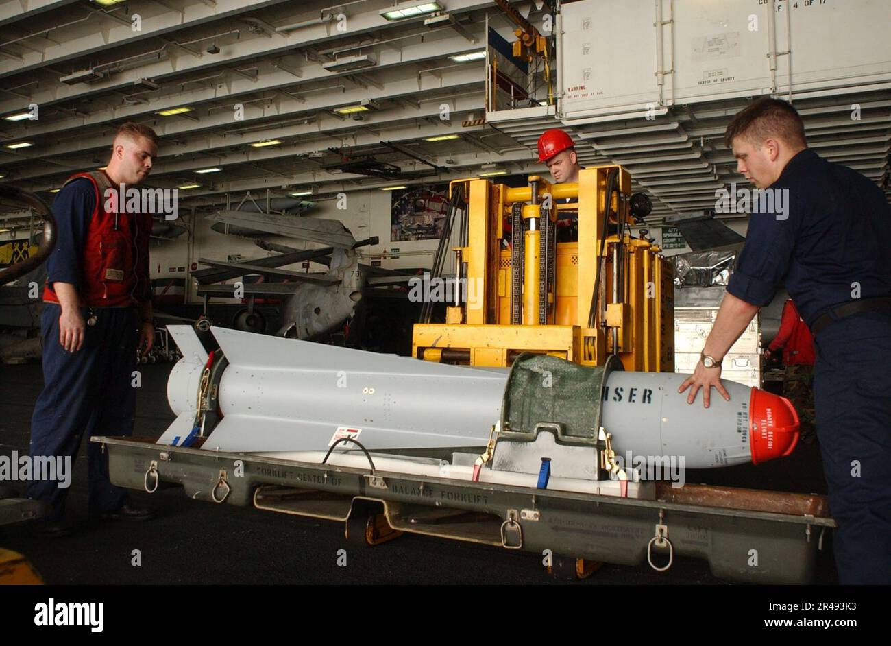 US Navy Aviation Ordnancemen move an AGM-65F Maverick air-to-surface ...