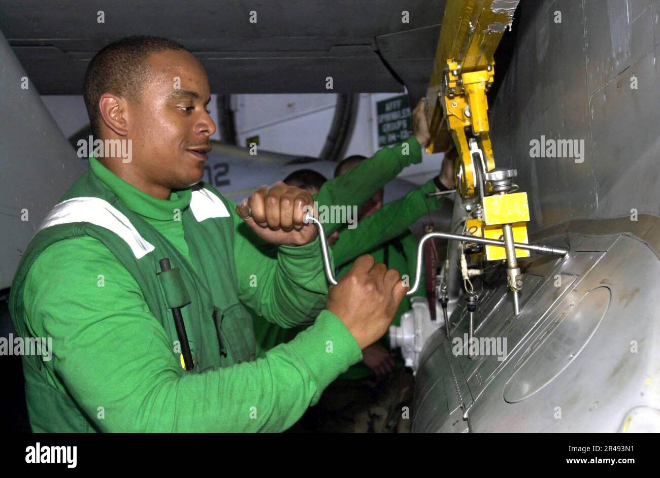 US Navy An Aviation Boatswain's Mate removes a forward-looking infrared ...