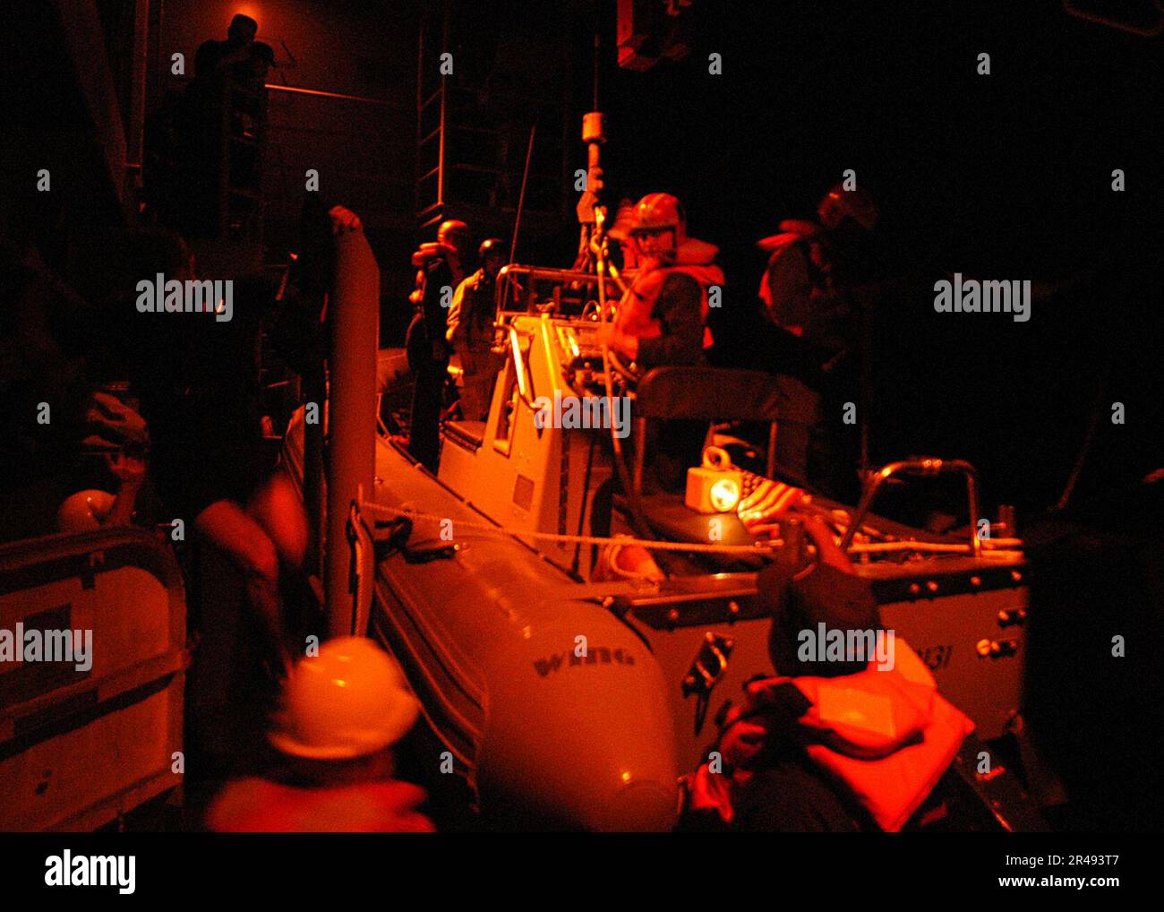 US Navy Deck Department personnel prepare for a night launch of a Rigid ...