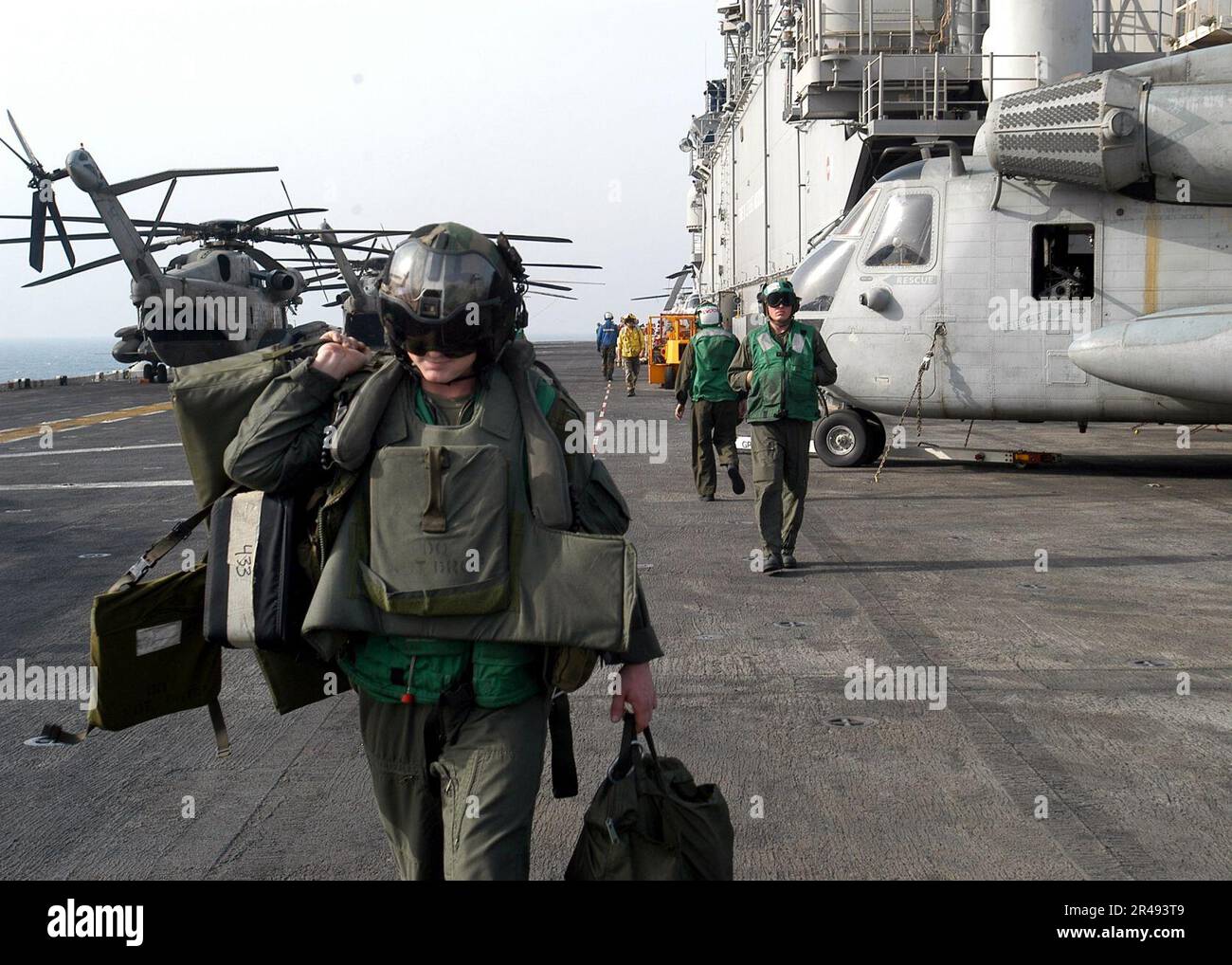 US Navy A U.S. Marine Aviator carries his flight gear to a CH-53E Super ...