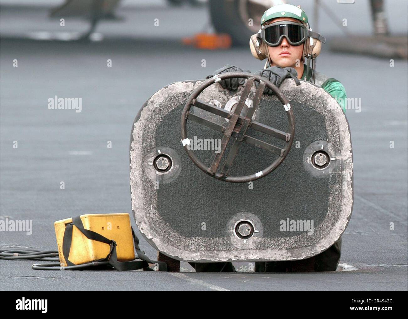 US Navy An Aviation Boatswain's Mate stands ready to engage the jet ...