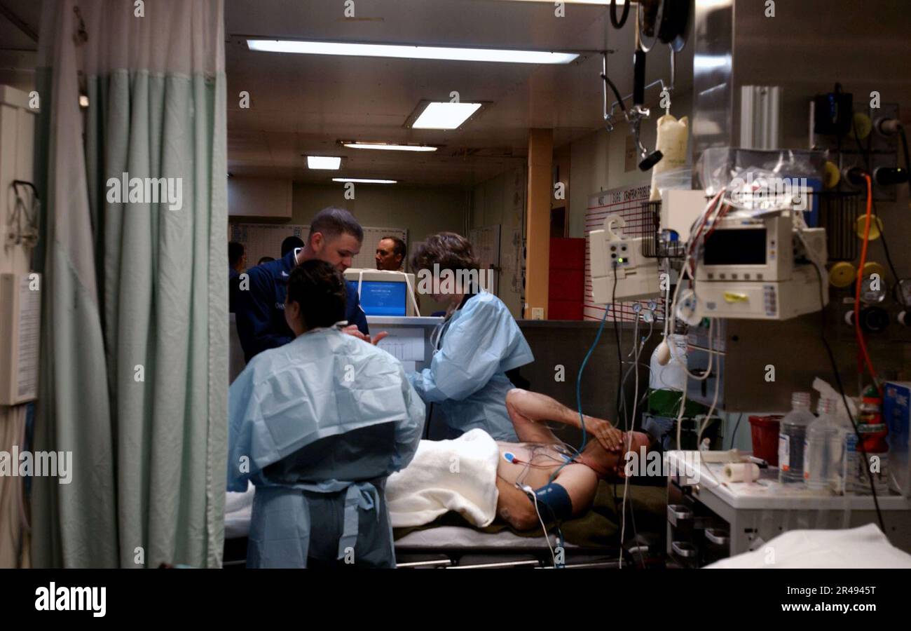US Navy Medical personnel work diligently on a wounded U.S. Marine ...