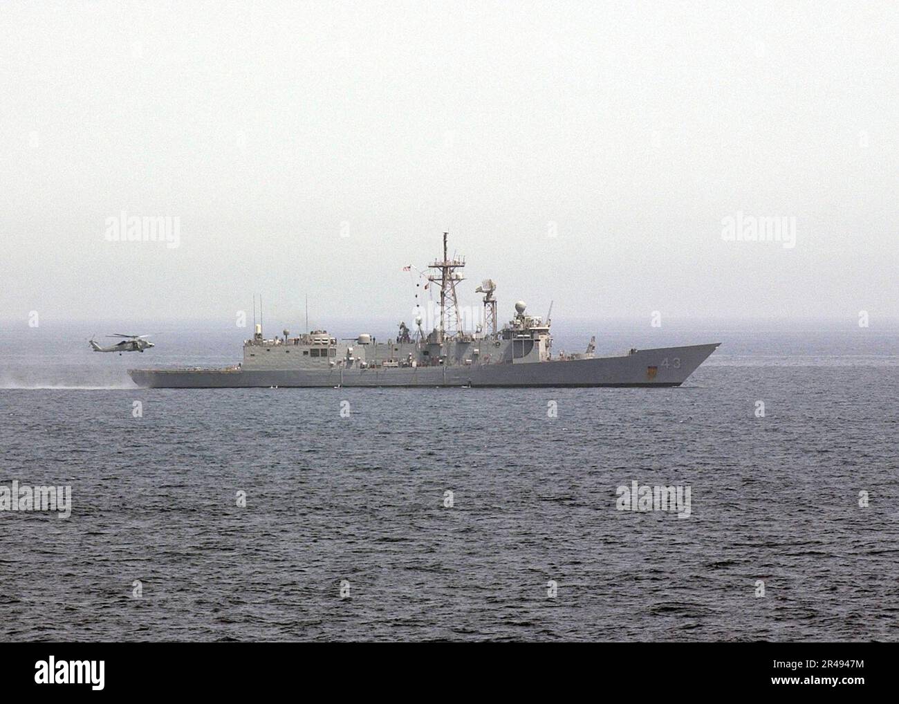 US Navy he guided missile frigate USS Thach (FFG 43) steams along as a ...