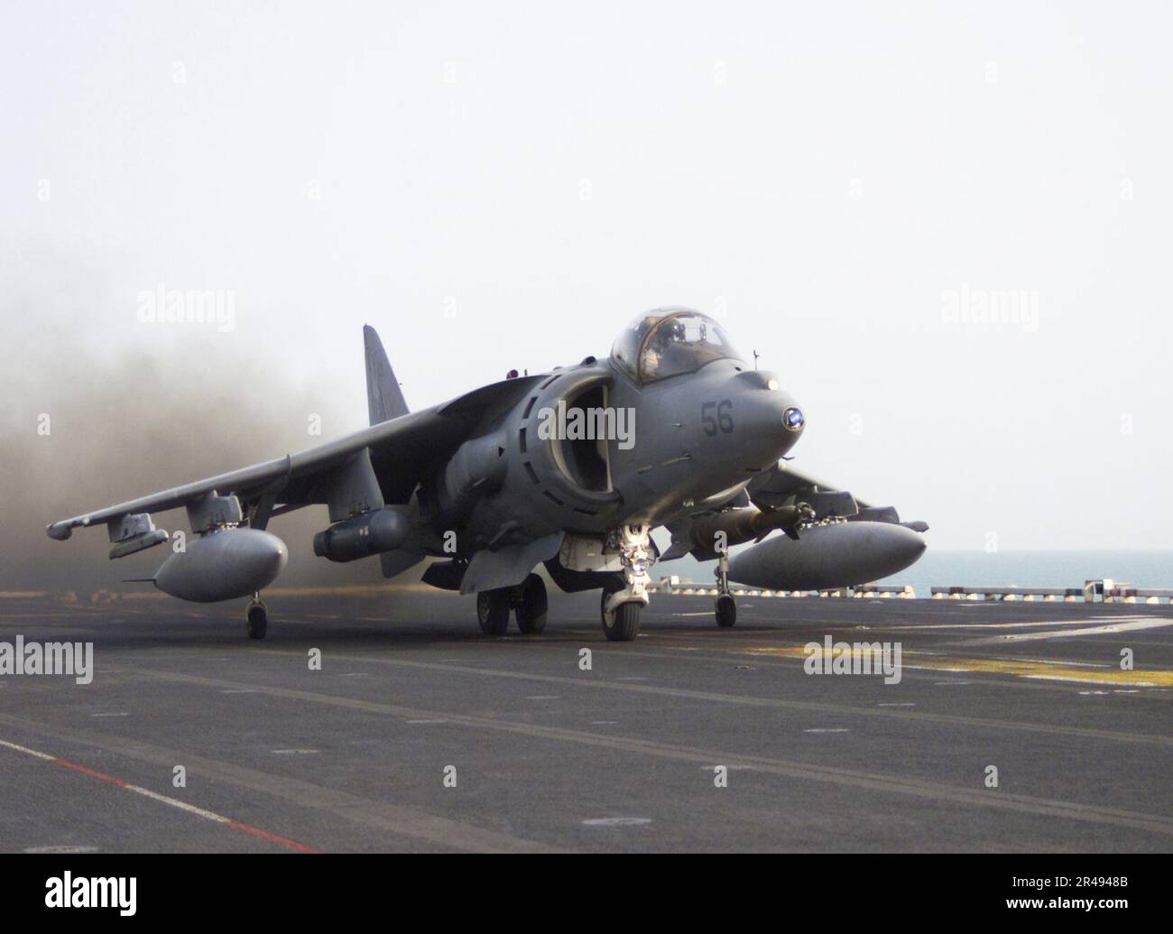 US Navy A Marine Corps AV-8B Harrier attack jet begins its takeoff roll on the flight deck of ...