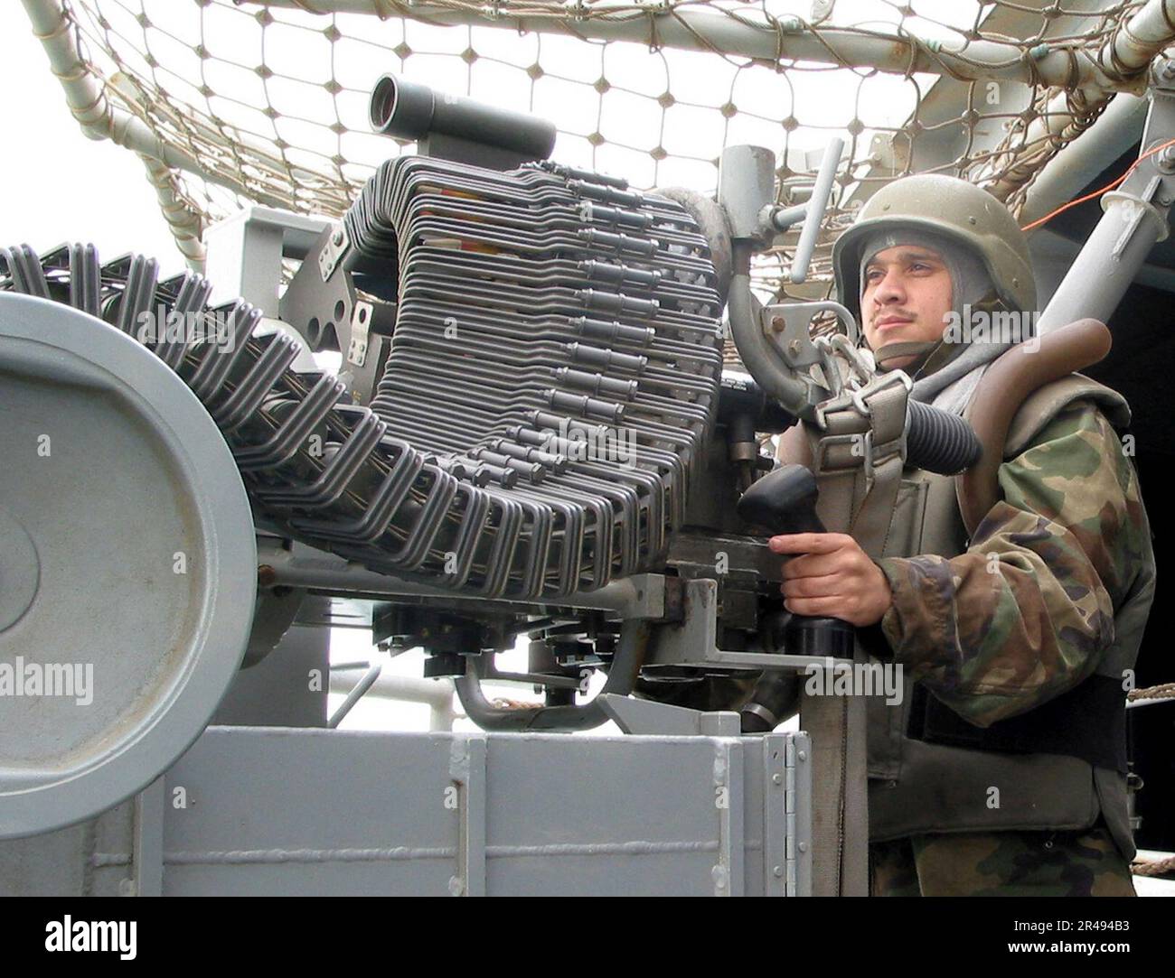 US Navy Airmen Leon Martinez III mans an MK-38 machine gun aboard the ...