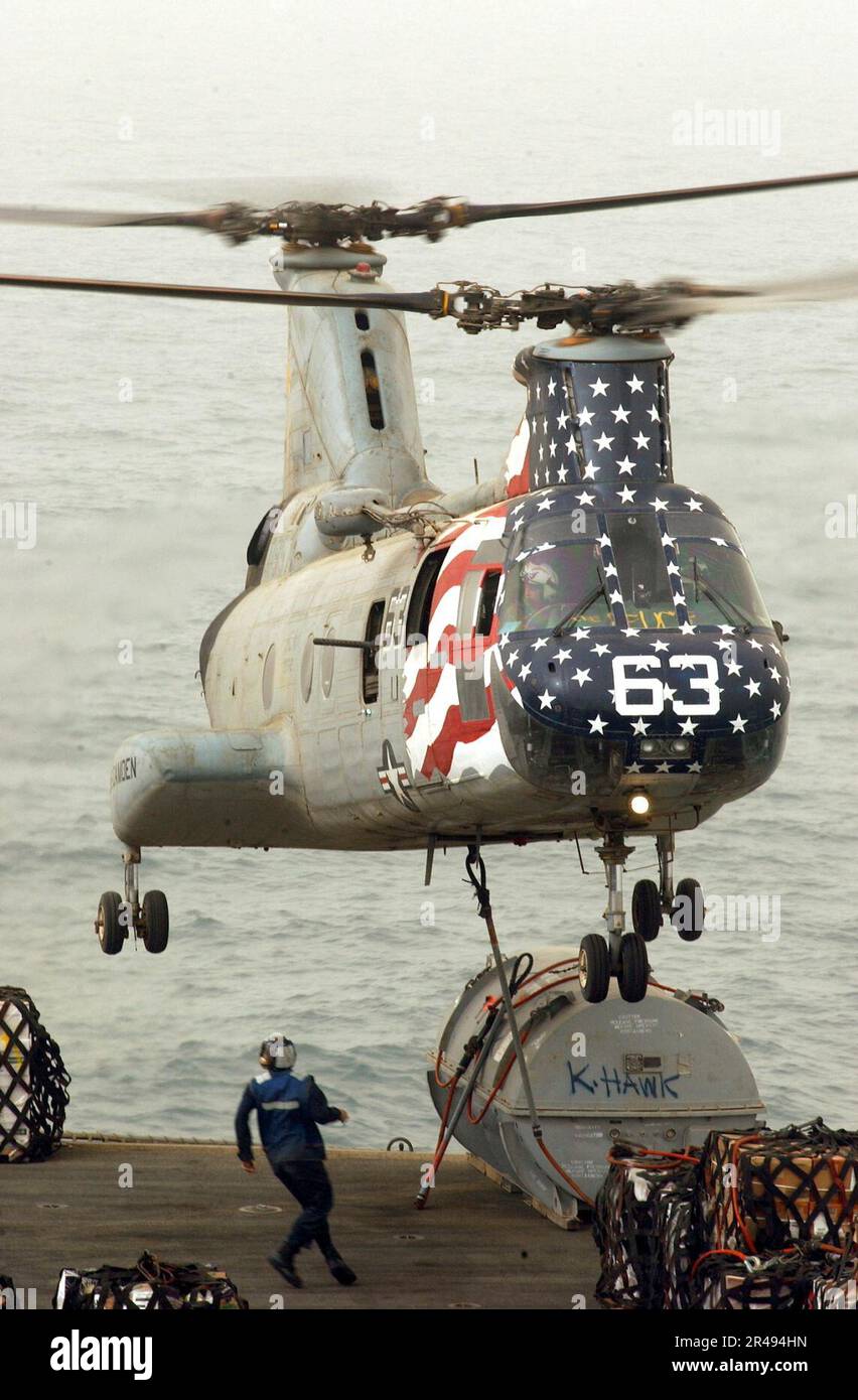 US Navy A CH-46 Sea Knight performs a vertical replenishment between ...