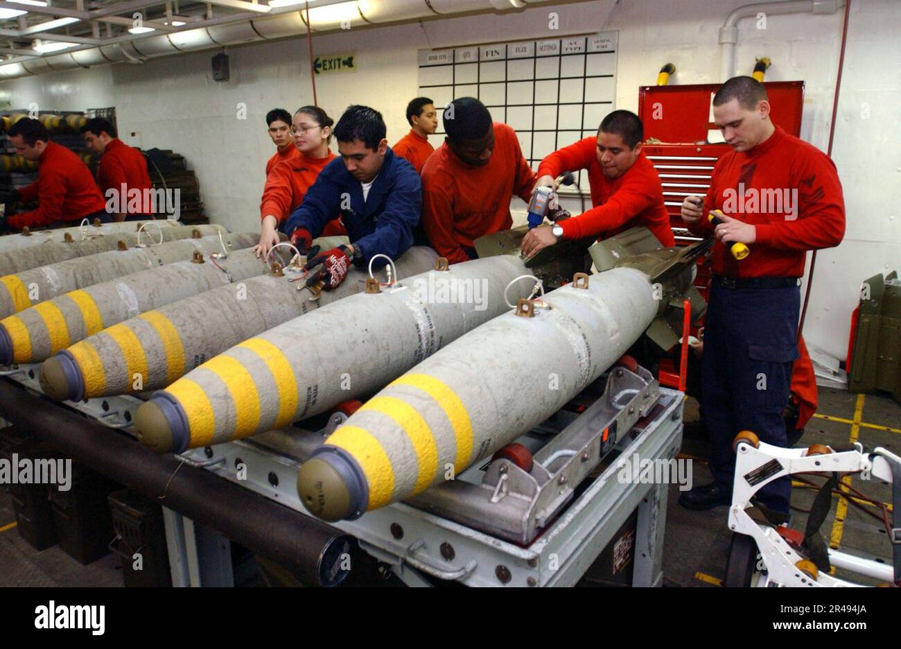US Navy Aviation Ordnancemen assemble bombs aboard USS Theodore ...