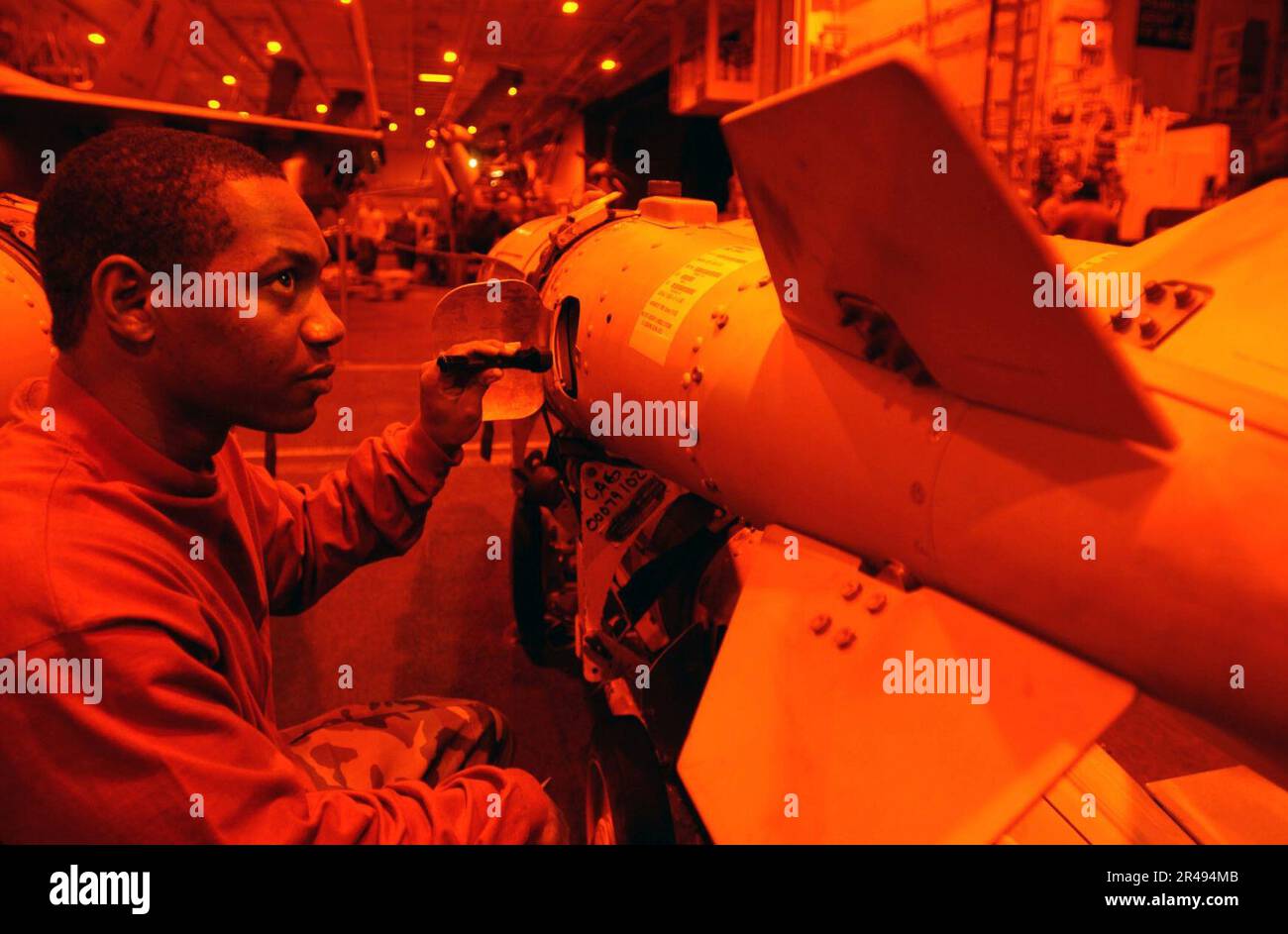 US Navy Aviation Ordnanceman complete checks of ordnance in the ship's ...