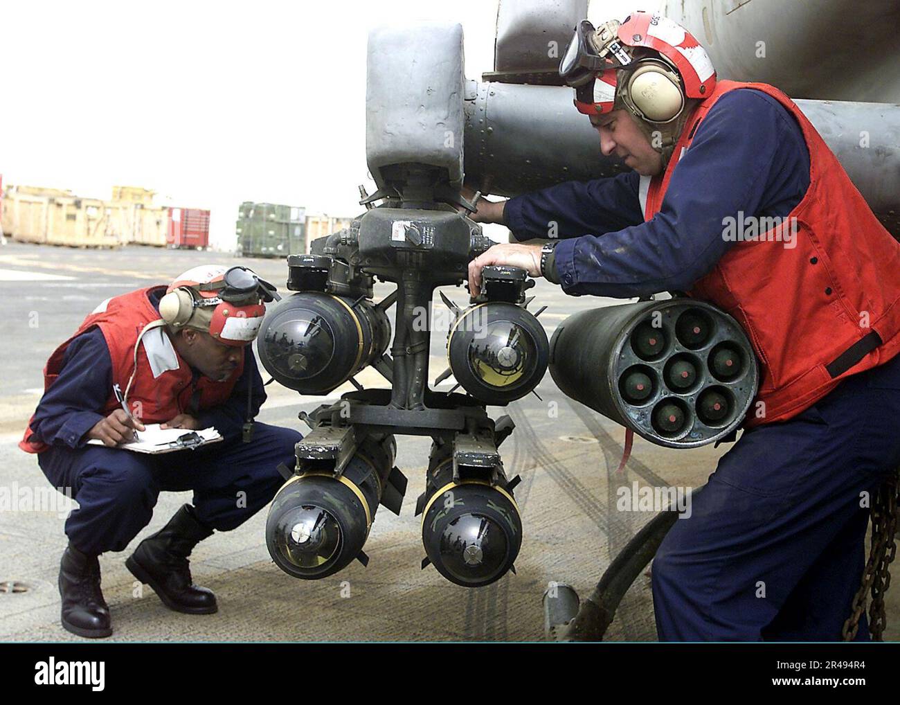 US Navy U.S. Marines inspect live ordnance on an AH-1W Super Cobra ...