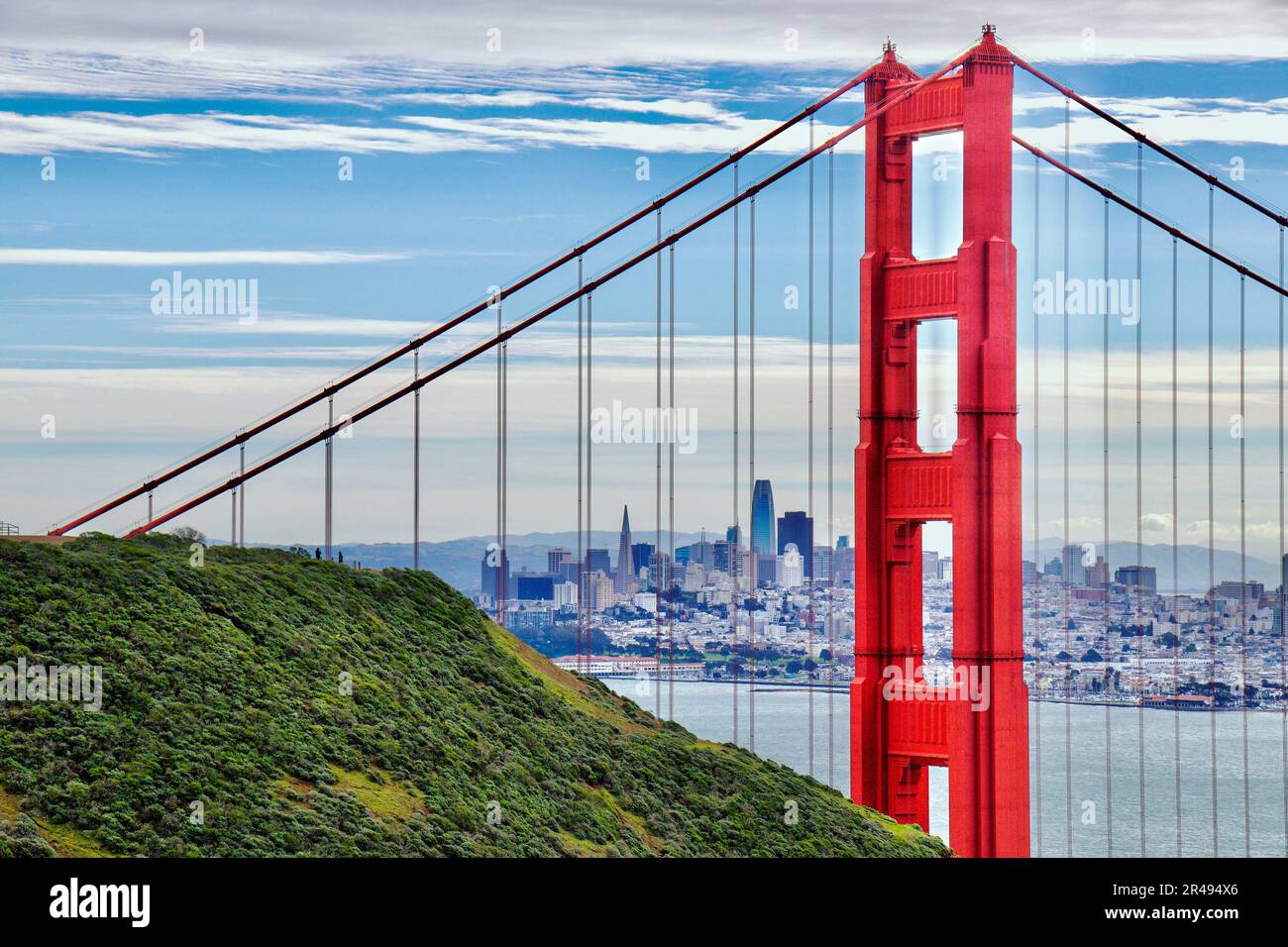 A scenic view of a vibrant red bridge spanning over a body of water ...