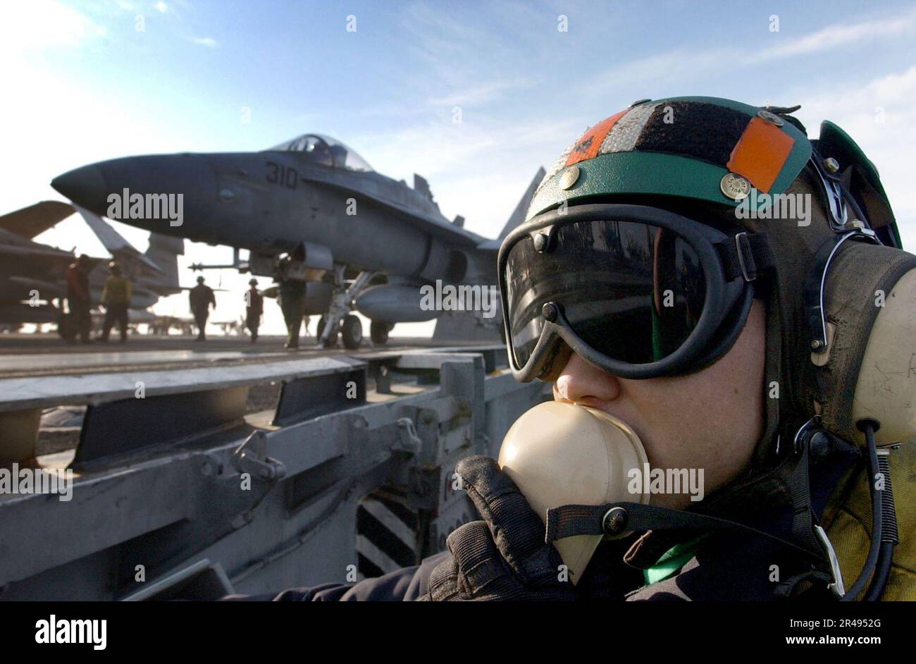 US Navy A Deck Edge Operator stands watch as an F-A-18 Hornet prepares ...