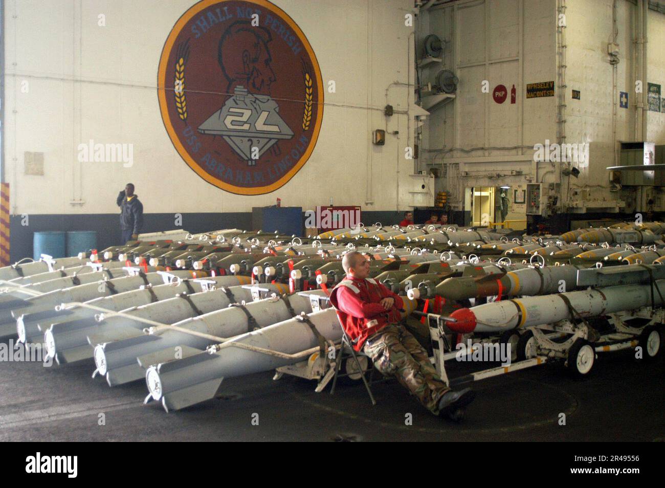 US Navy An Aviation Ordnanceman assigned to the weapons department ...