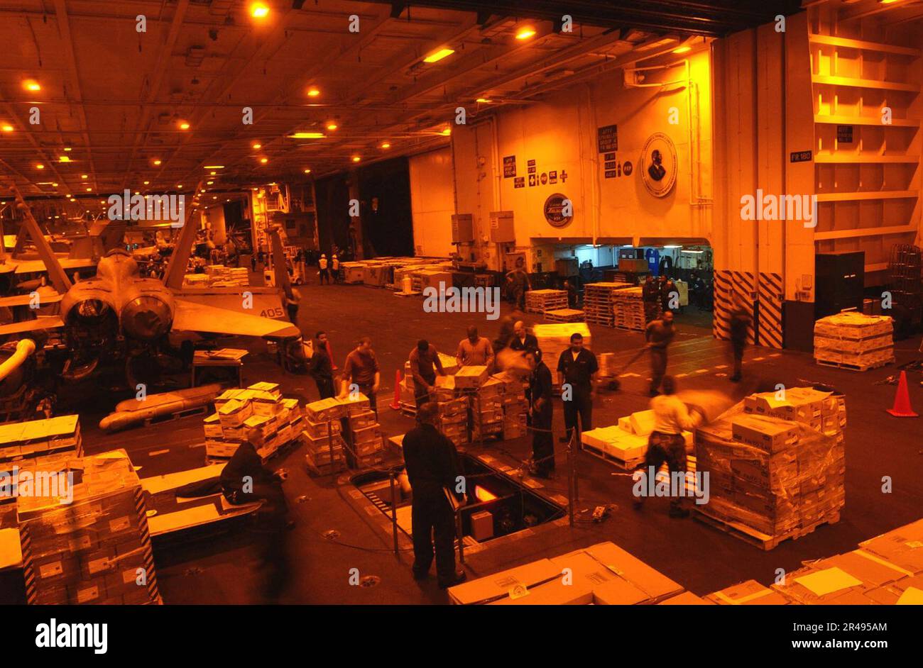 US Navy Sailors and Marines participate in a working party to transfer ...