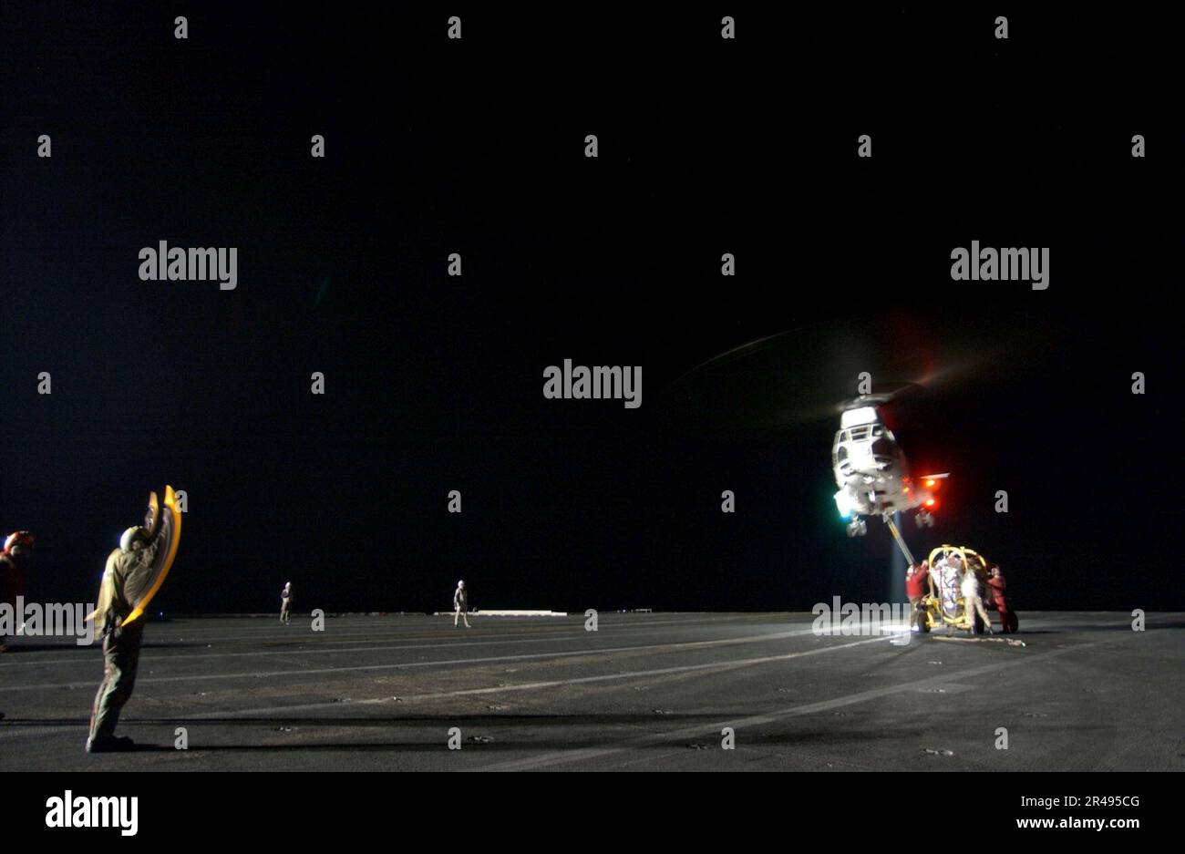 US Navy An Aviation Boatswains Mate directs a SA-330 Puma helicopter to ...