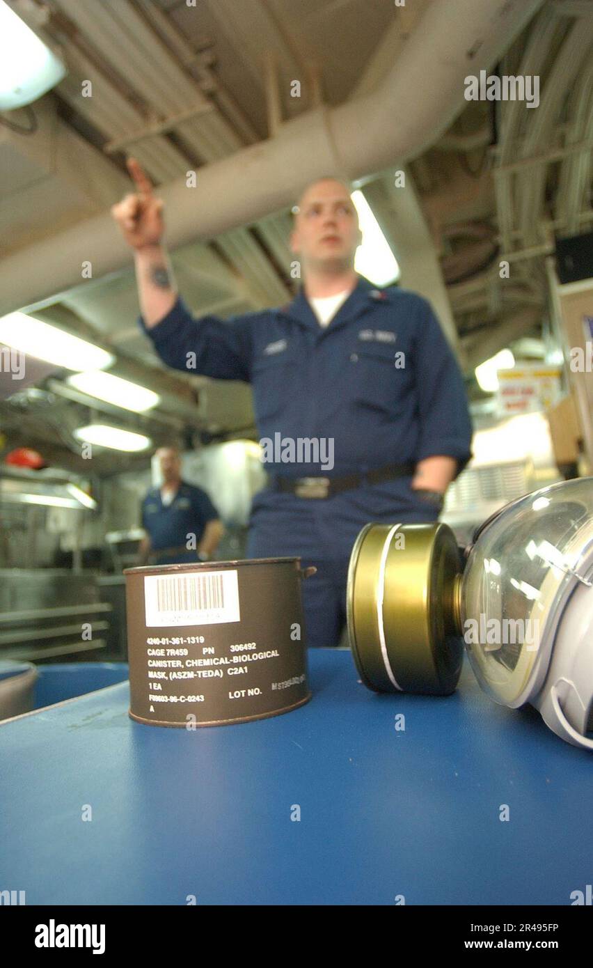 US Navy Damage Controlman 1st Class instructs crewmembers aboard the ...