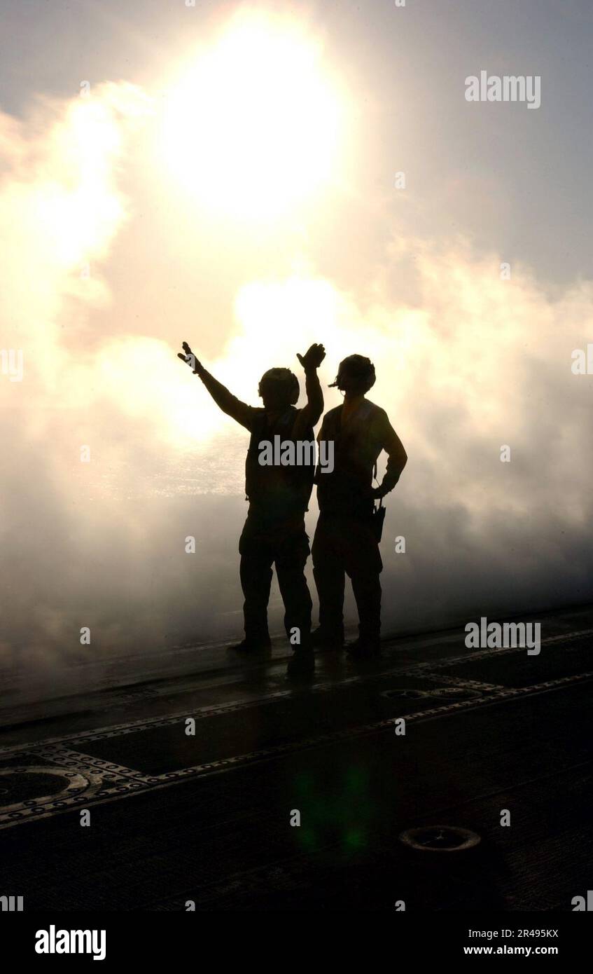 US Navy Aircraft Directors use hand-signals while engulfed with steam ...