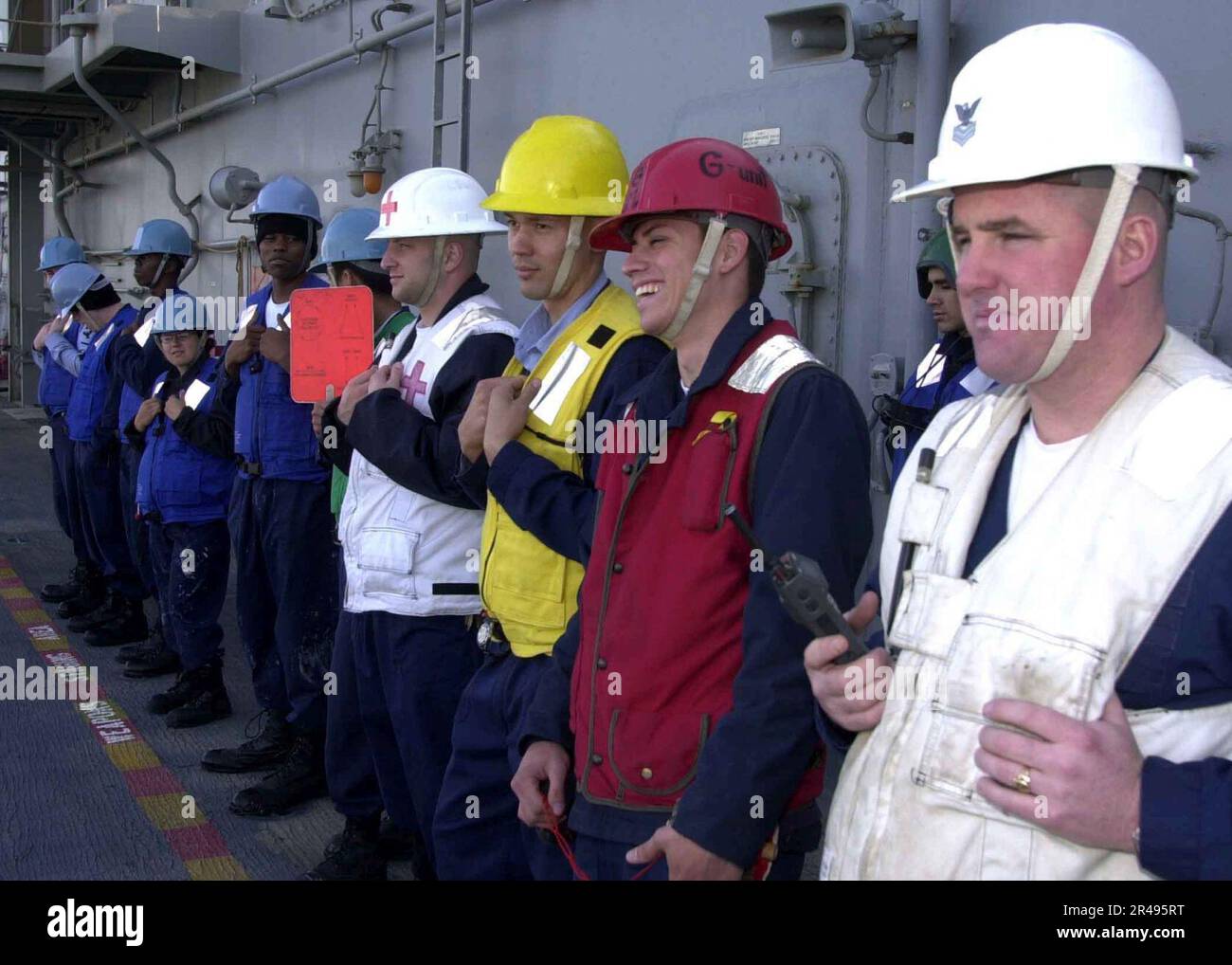 US Navy Line handlers aboard the amphibious assault ship USS Bataan ...