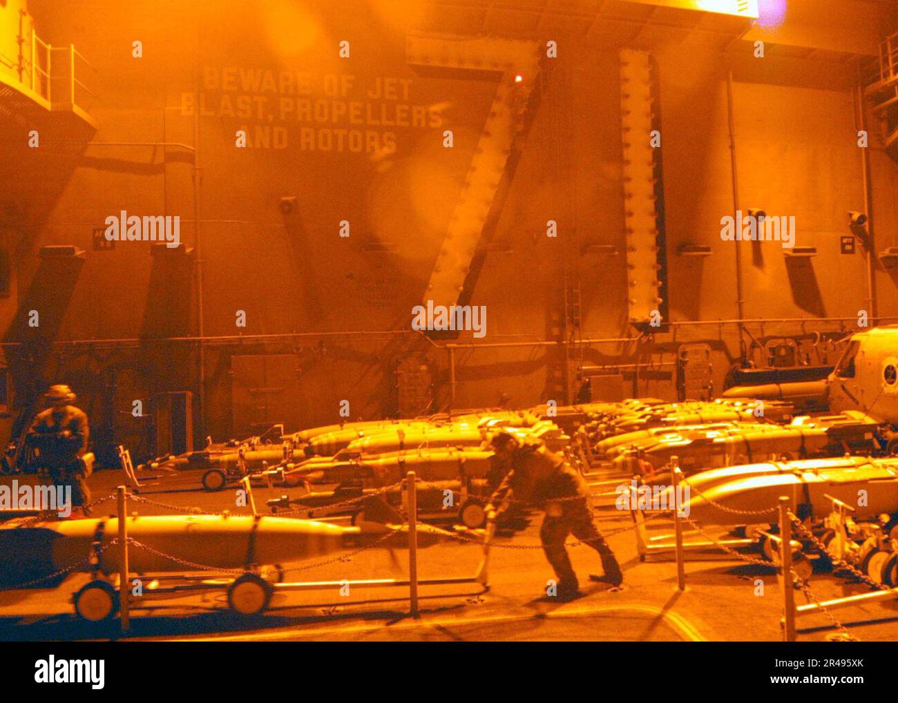 US Navy Aviation Ordnancemen move ordnance to Carrier Air Wing Eight ...