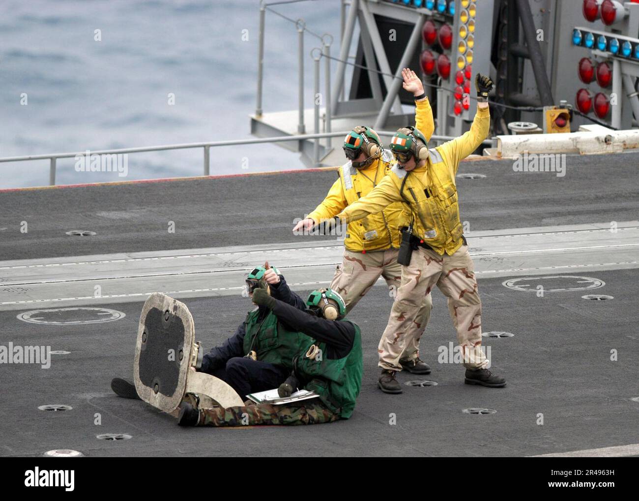 US Navy A flight deck Shooter and trainee gives the launch signal to ...