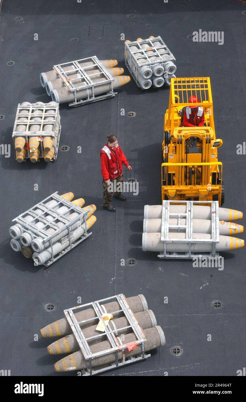 US Navy Aviation Ordnancemen safely transfer ordnance from an aircraft ...