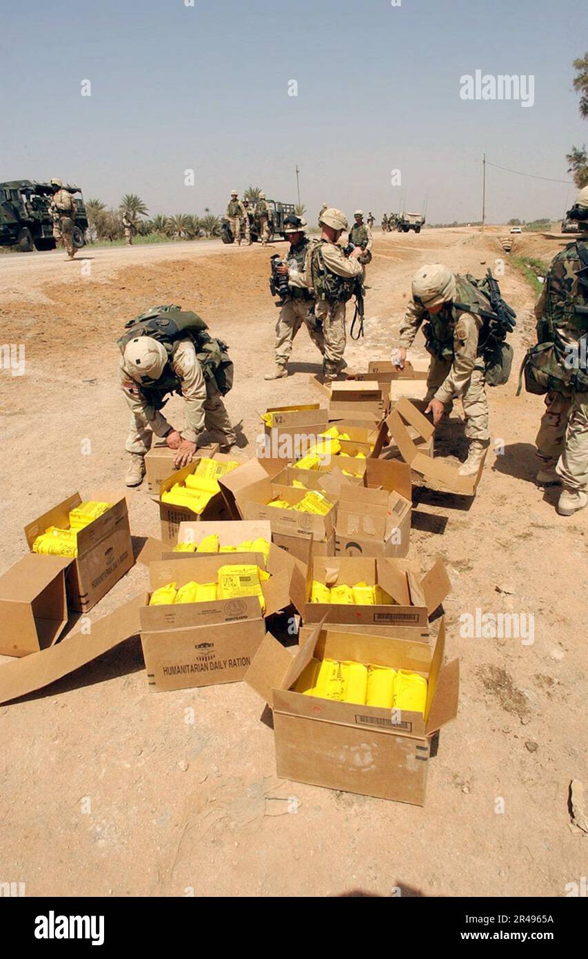 US Navy Paratroopers assigned to the 82nd Airborne Division open boxes ...