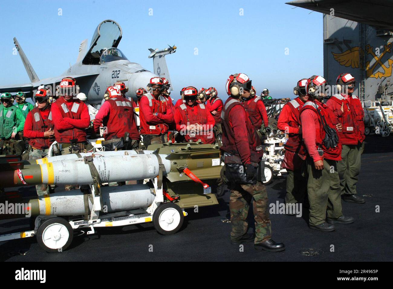 US Navy Aviation Ordnancemen await the recovery of incoming Carrier Air ...