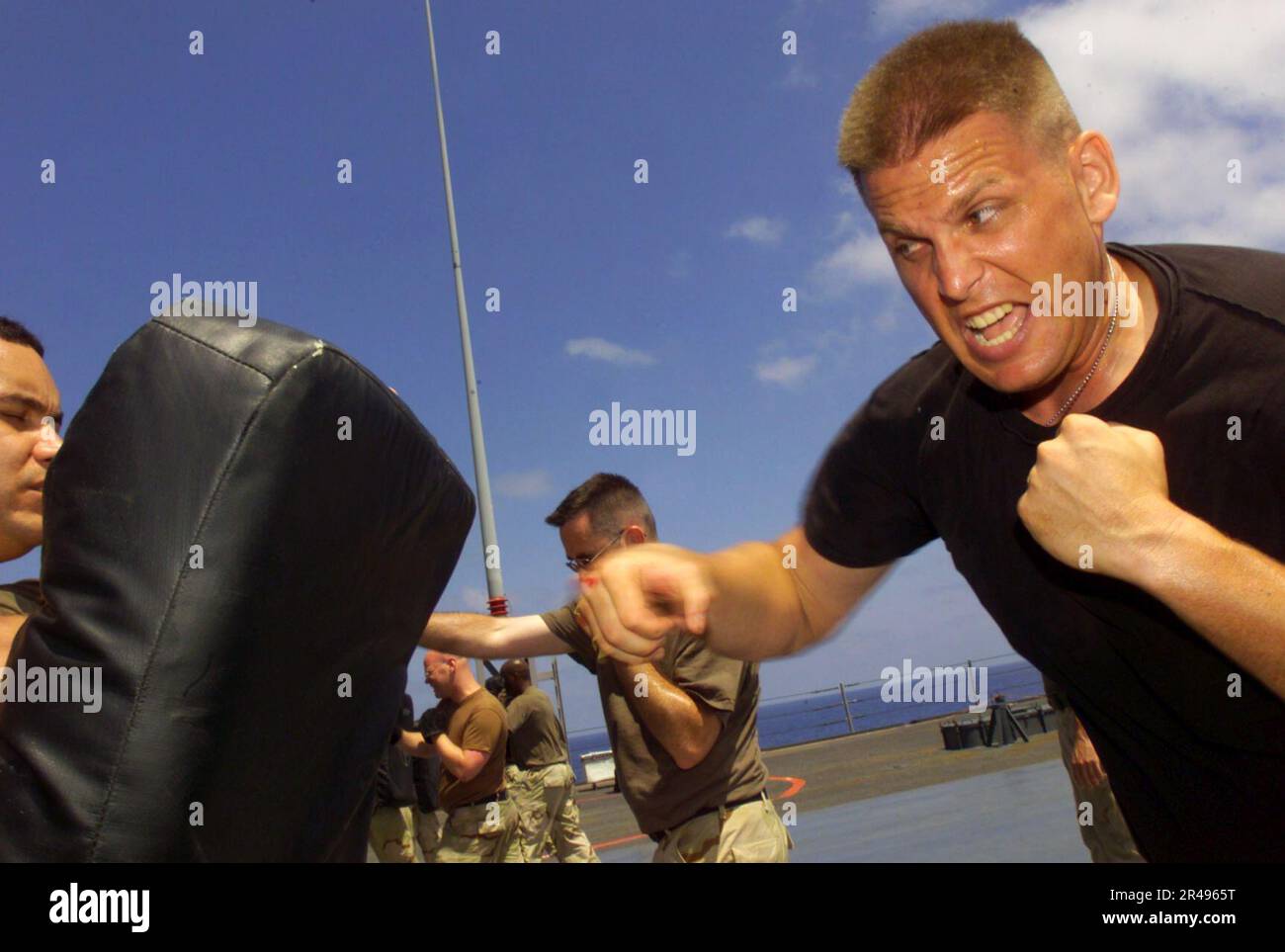 US Navy U.S. Marine SSgt. practices an eye-gouging technique during a ...