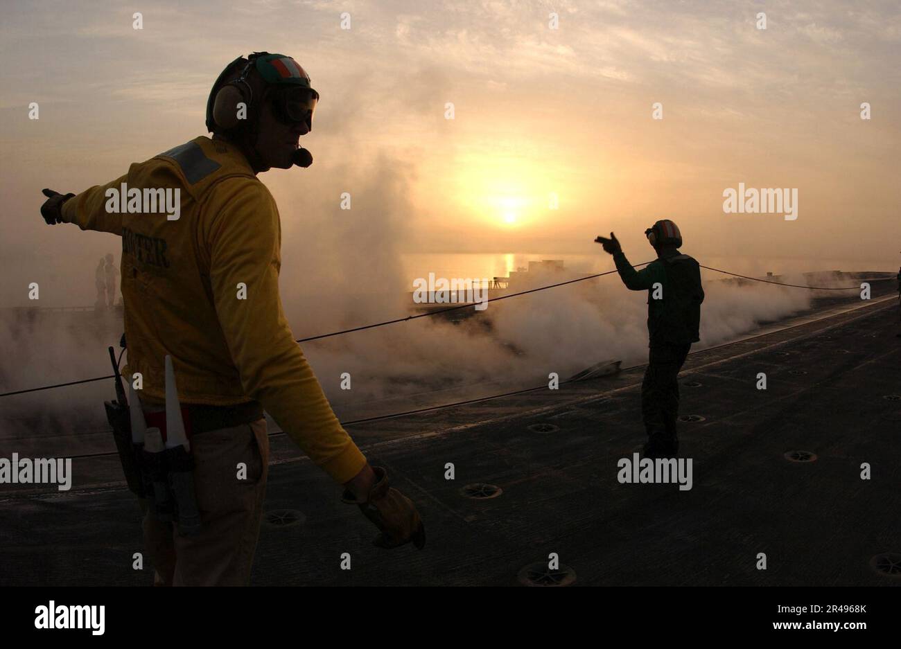 US Navy A shooter assigned to the V-2 waist catapult, signals return of ...