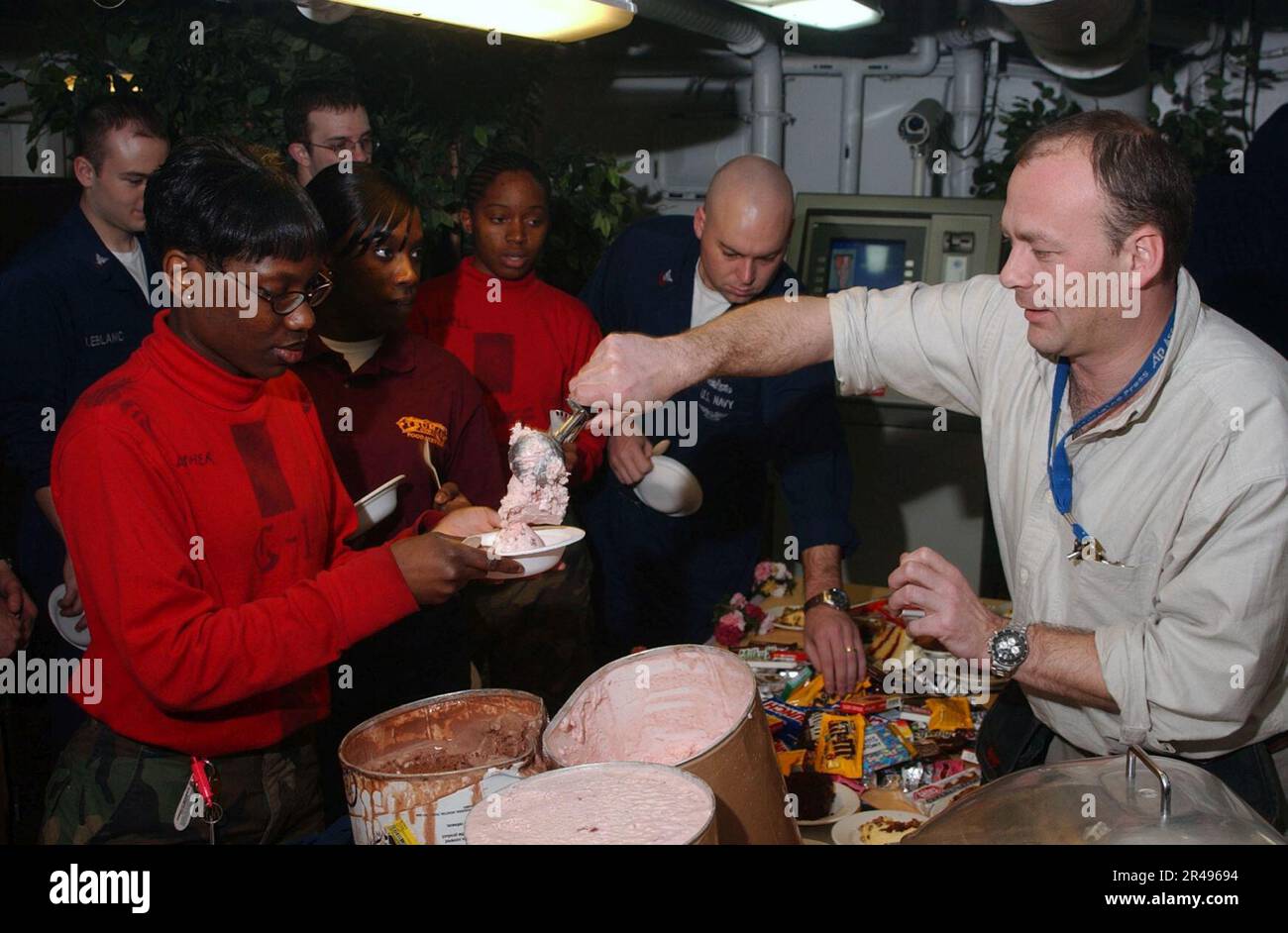 US Navy Members of embarked civilian media serve ice cream to Sailors ...