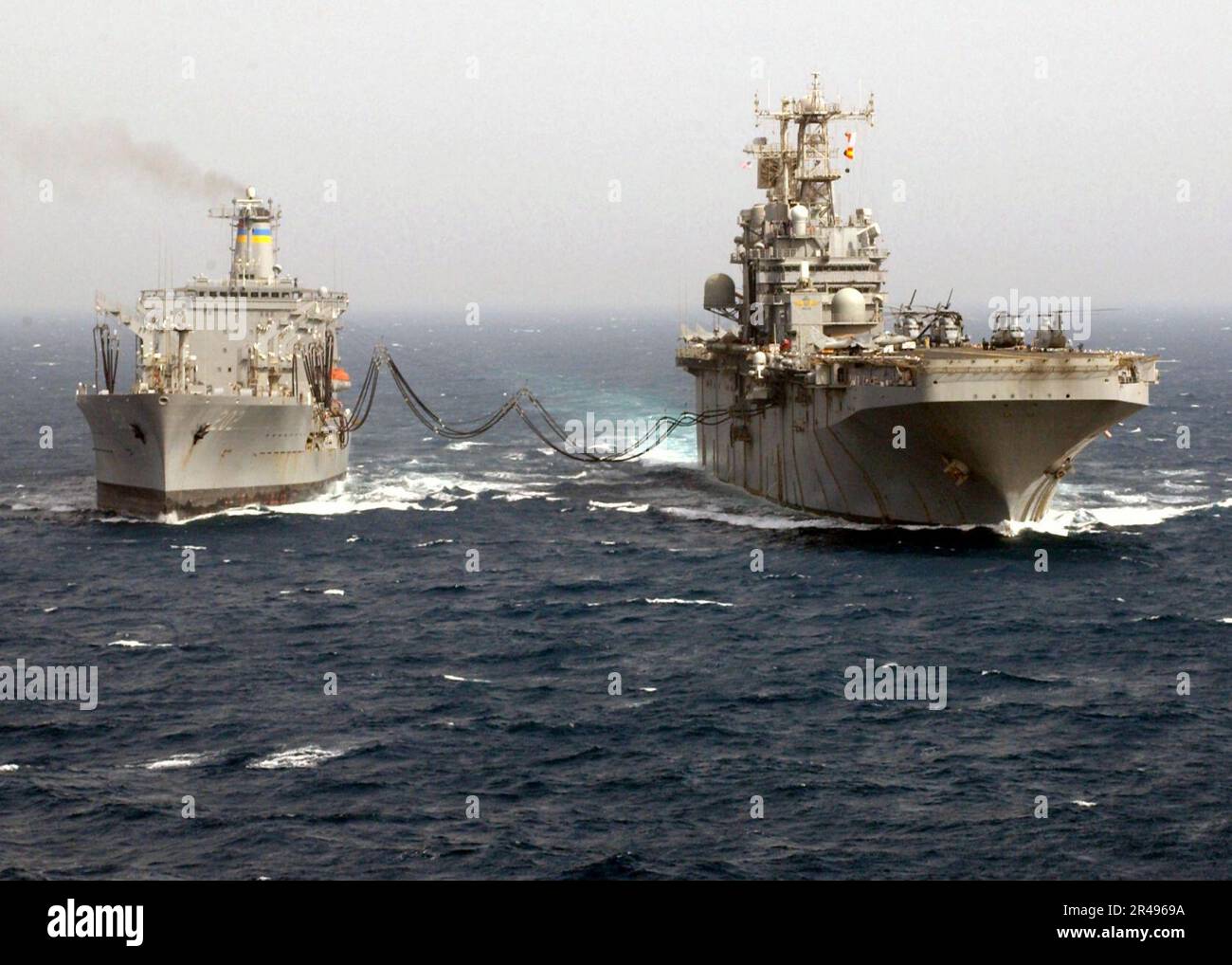 US Navy USS Tarawa (LHA 1) receives fuel during an underway ...