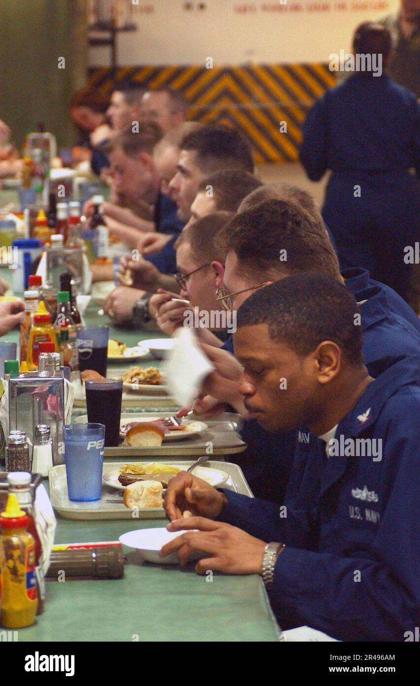 US Navy Sailors and Marines enjoy dinner and ice cream on the mess ...
