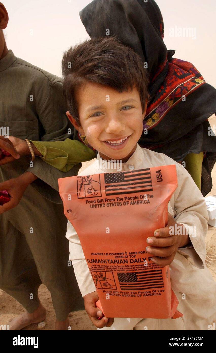 US Navy An Iraqi boy holds a humanitarian food ration given to him by U ...