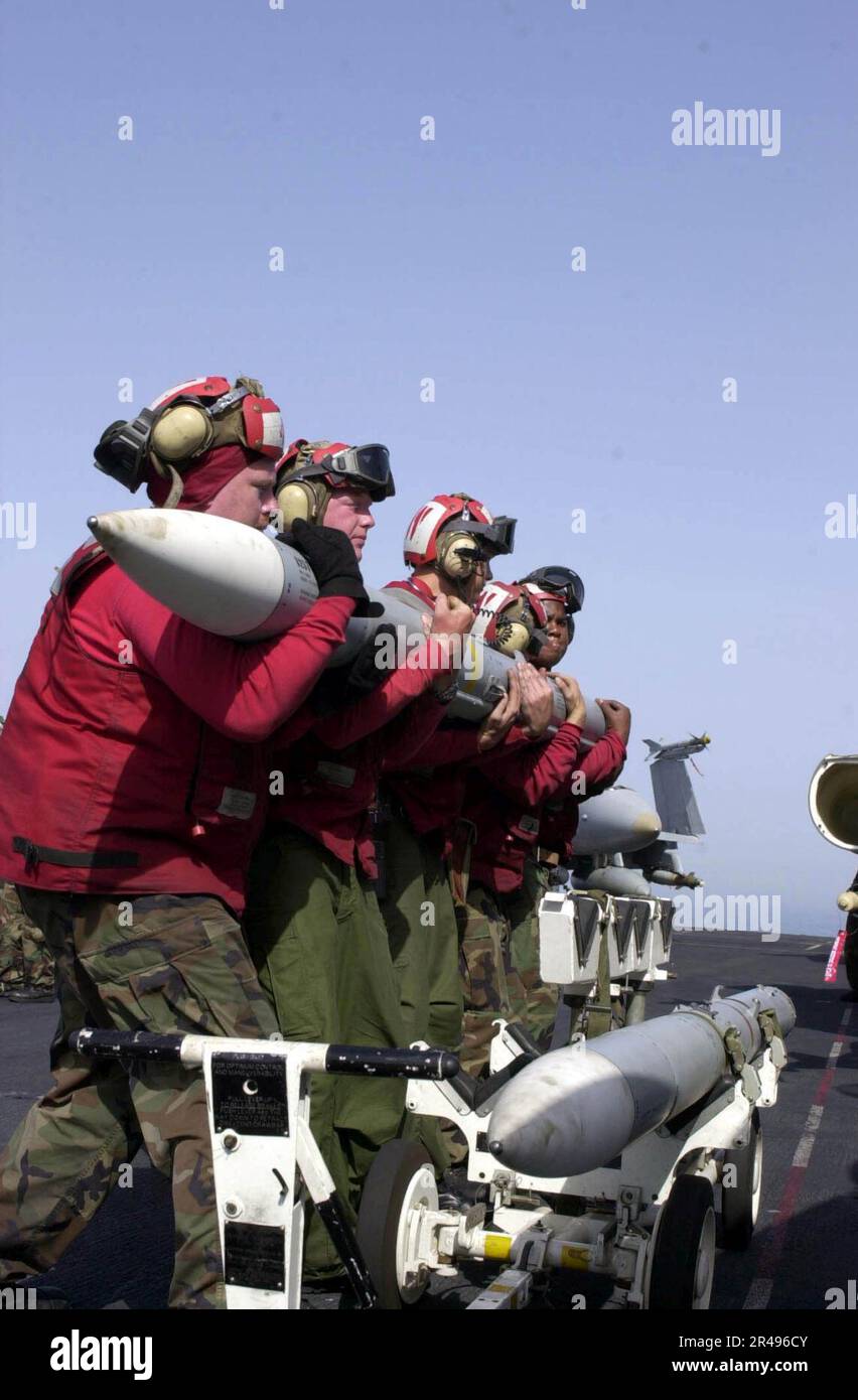 US Navy Aviation Ordnancemen lift an Advanced, Medium-Range, Air-to-Air ...