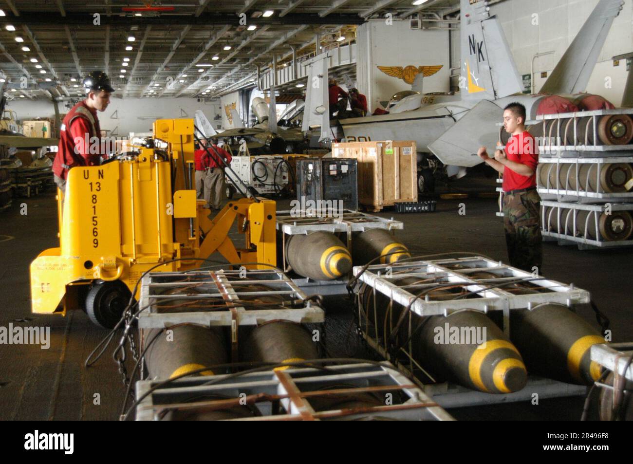 US Navy Sailors assigned to the Weapons Department G-4 Division use ...