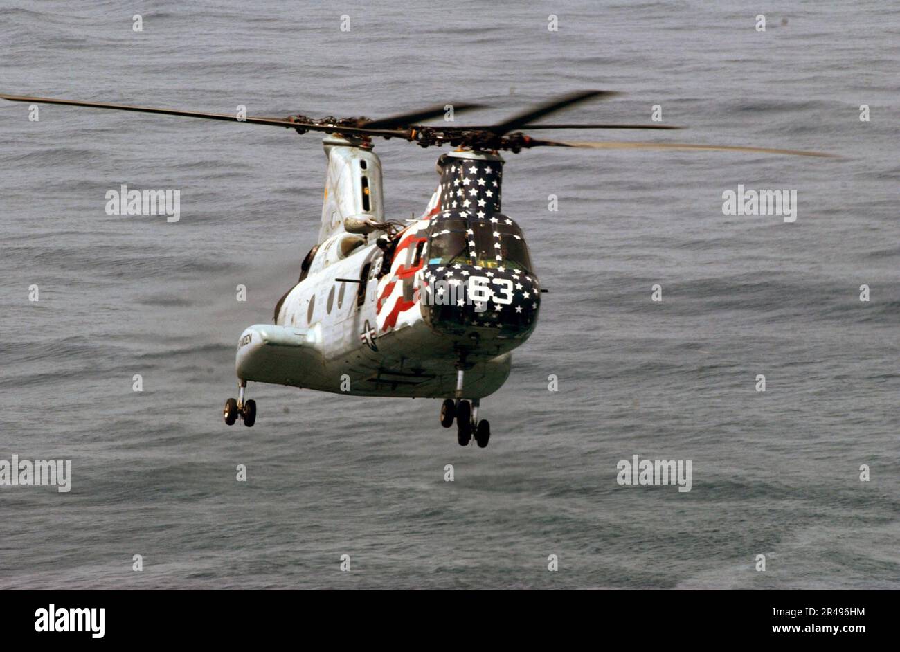 US Navy A CH-46 Sea Knight helicopter conducts a replenishment at sea ...