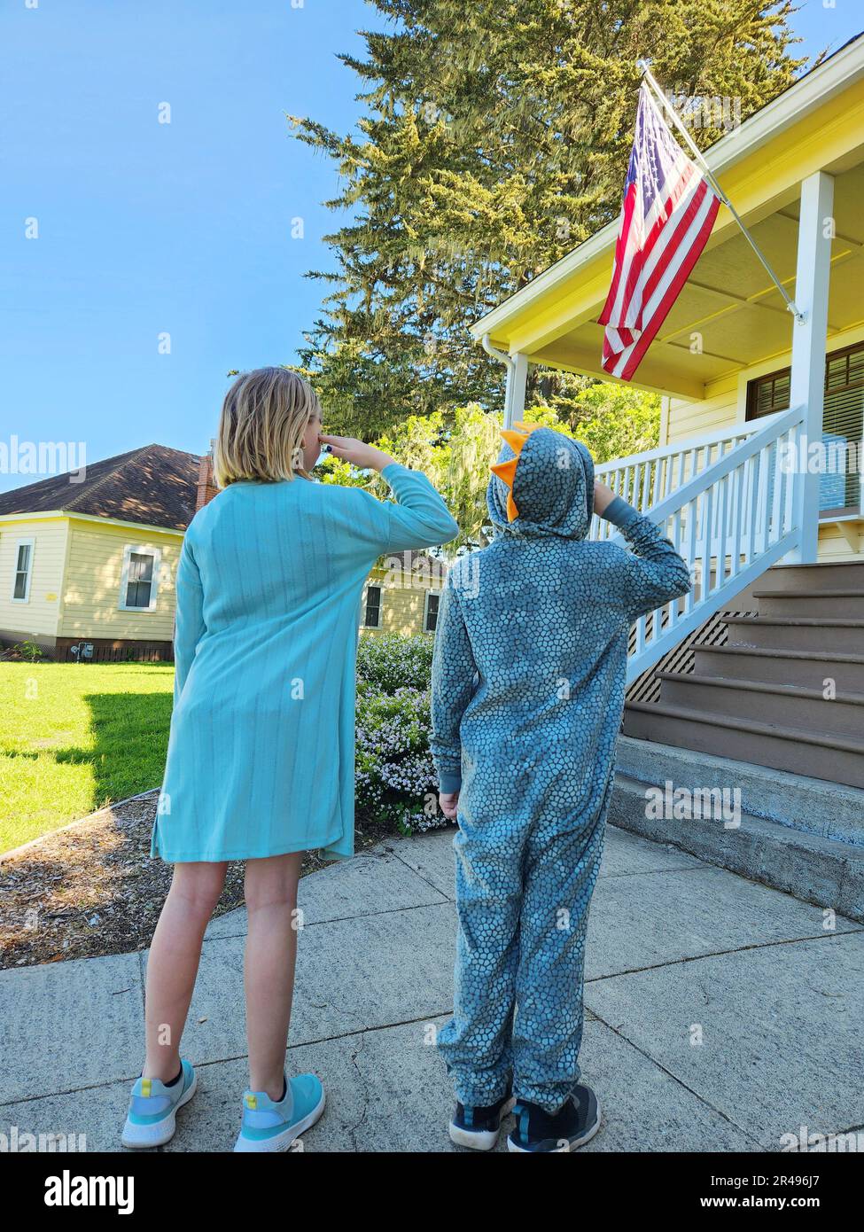 Lillian and Lucas Beavers, military children, salute the flag at the ...